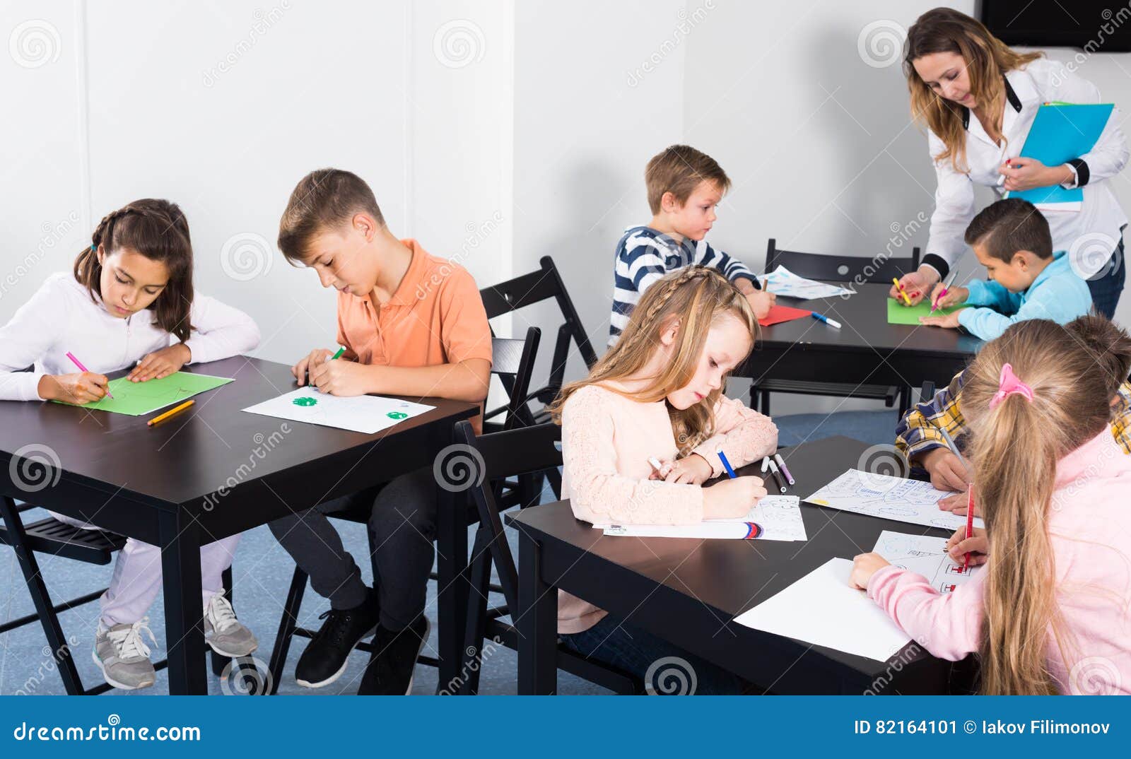 Attentive Little Children with Teacher Drawing in Classroom Stock Image ...