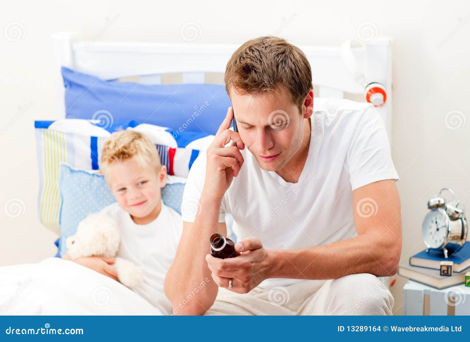 Attentive Man Looking after His Sick Son Stock Photo - Image of ...
