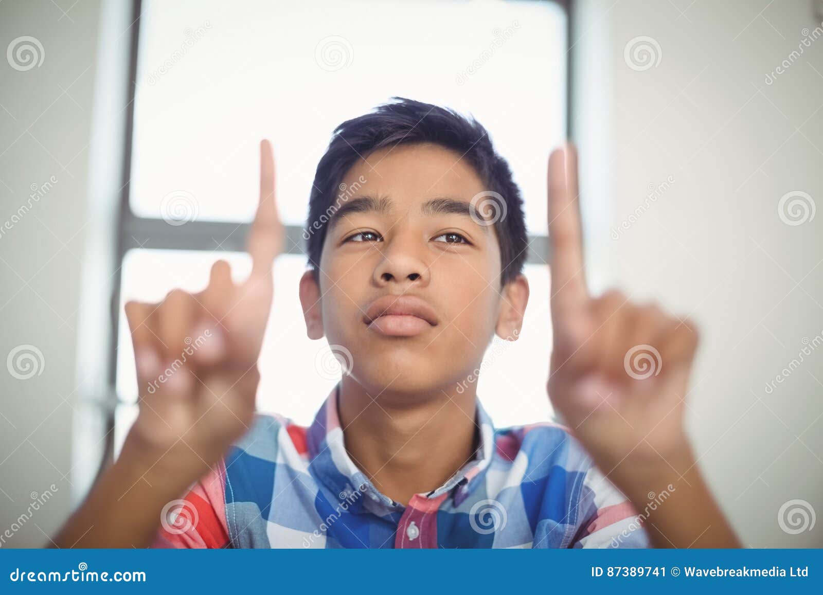 Attentive Schoolboy Gesturing in Classroom Stock Image - Image of ...