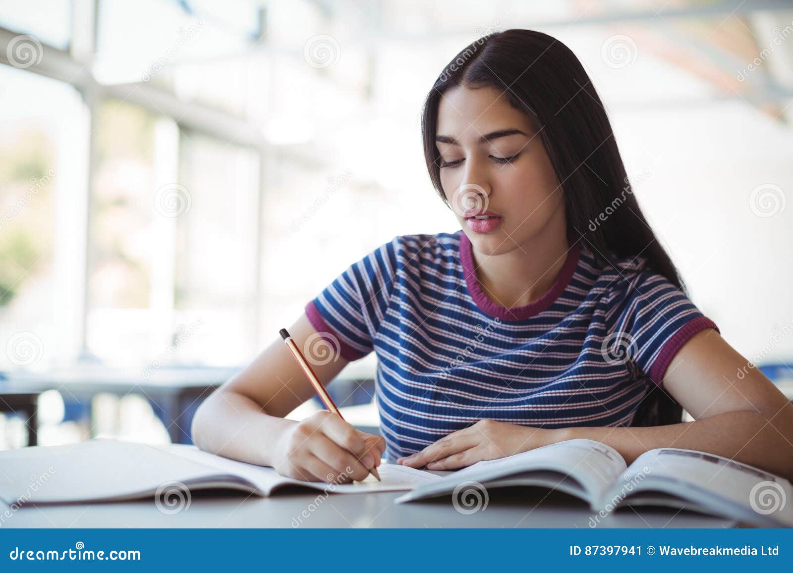 Attentive Schoolgirl Doing Homework in Classroom Stock Image - Image of ...