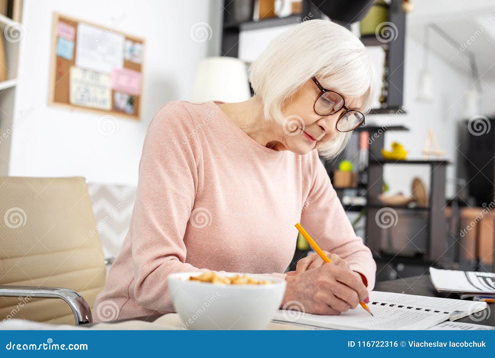 Attentive Senior Woman Writing Exercise Stock Photo - Image of mature ...