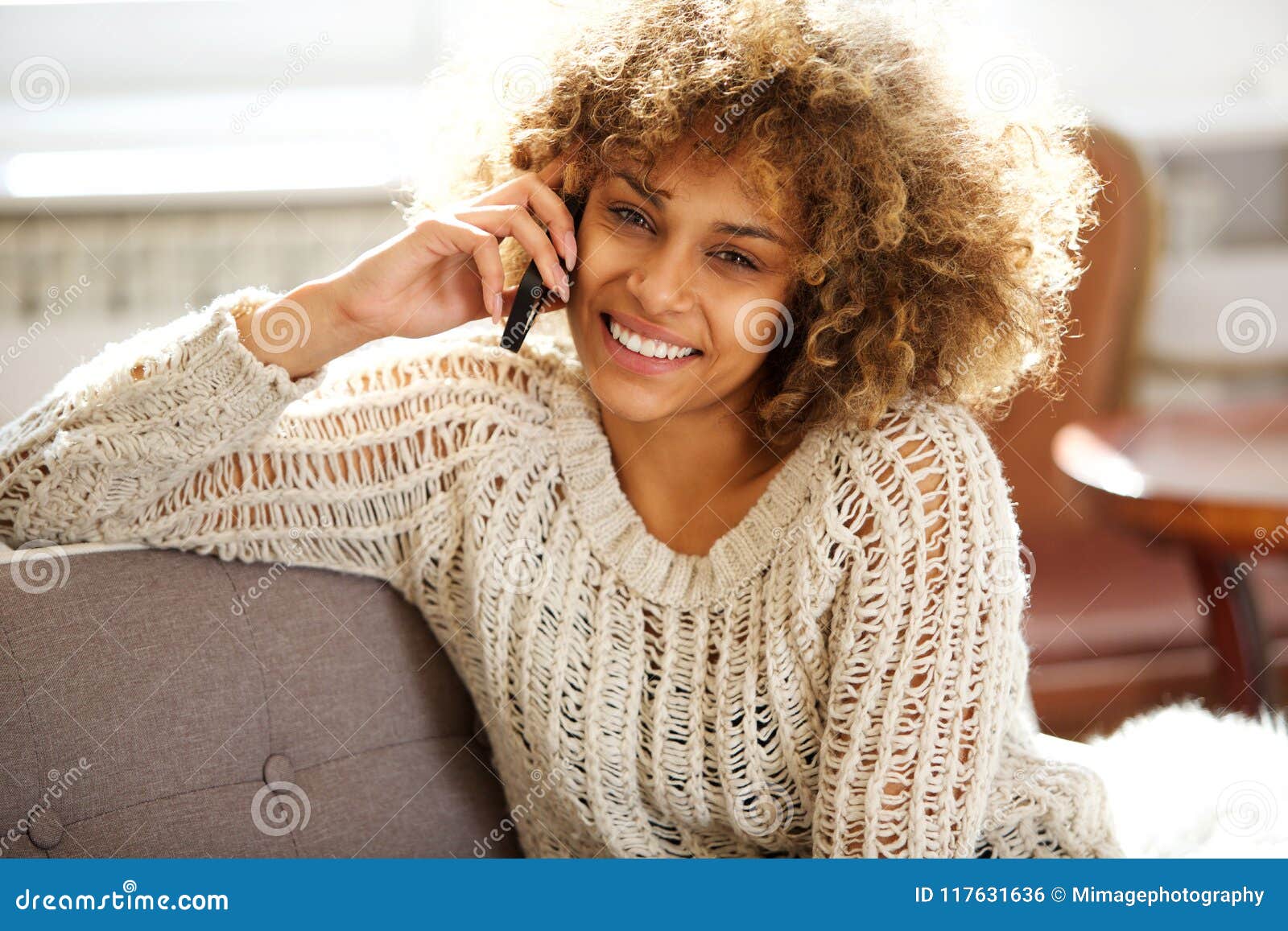 Attractive African American Woman Relaxing At Home And Talking On