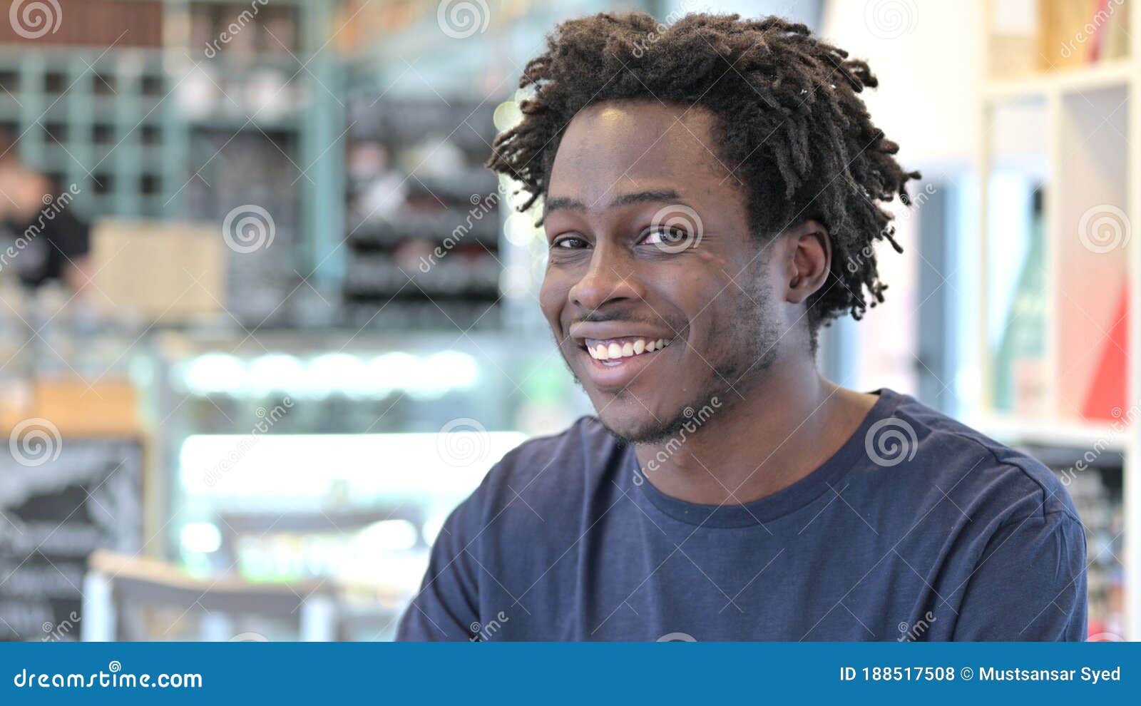 Attractive African Man Smiling at Camera Stock Photo - Image of working ...