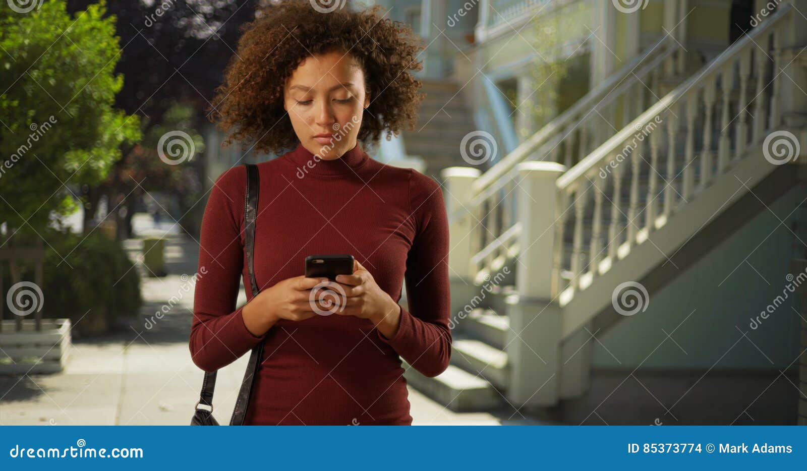 Attractive African Woman Texting on Sidewalk Stock Photo - Image of ...