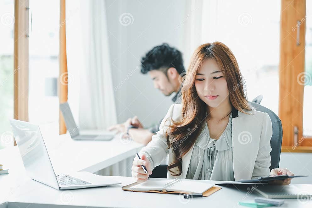 Attractive Asian Business People Working Together at Modern Office ... Attractive Asian Business People Working Together at Modern Office ...