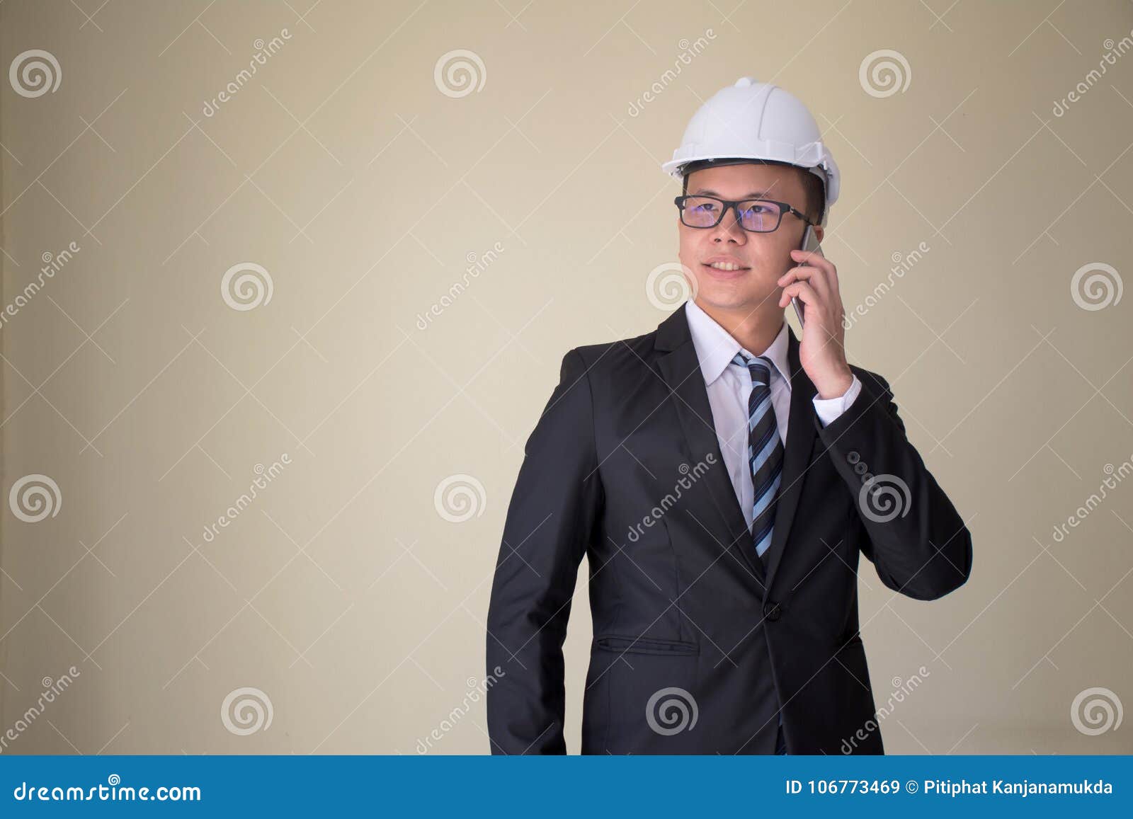 Attractive Asian Engineering in a Suit Using Mobile Phone Stock Image ...