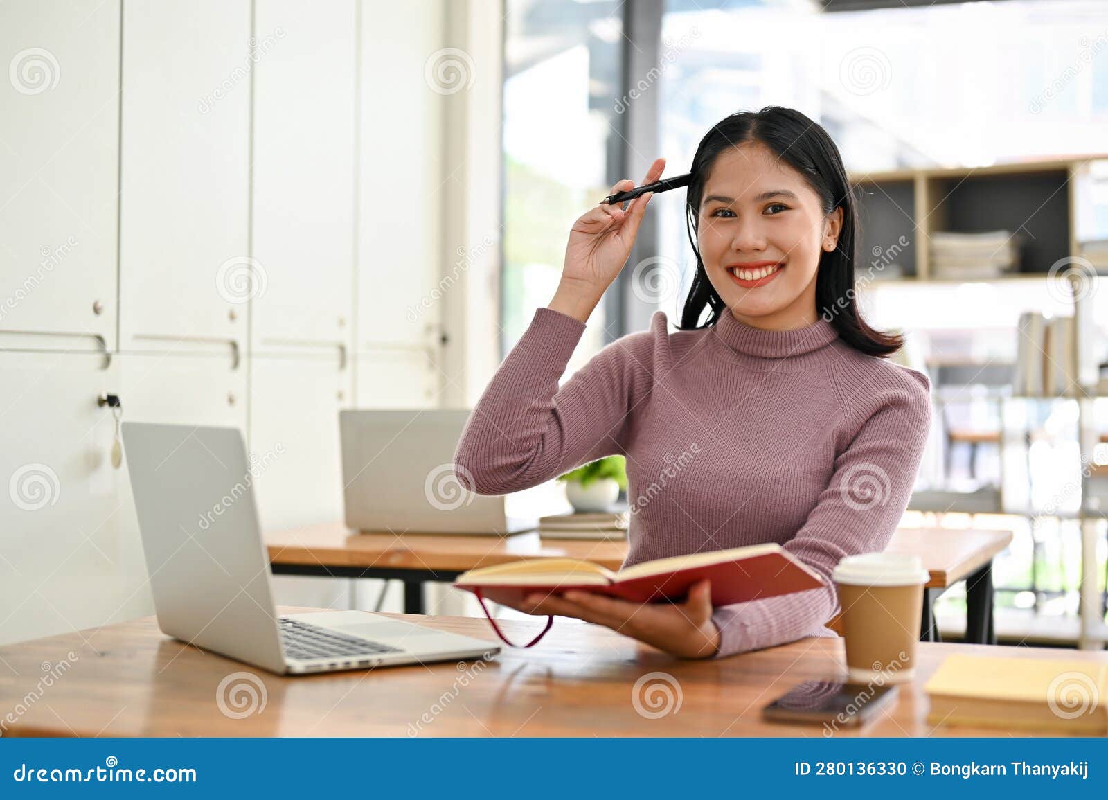 Attractive Asian Female College Student Doing Homework at Her Campus Co ...