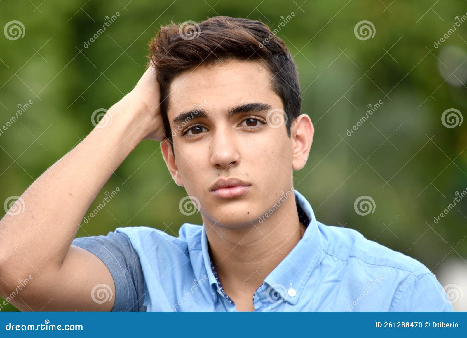 A Forgetful Hispanic Boy stock photo. Image of young - 261288470
