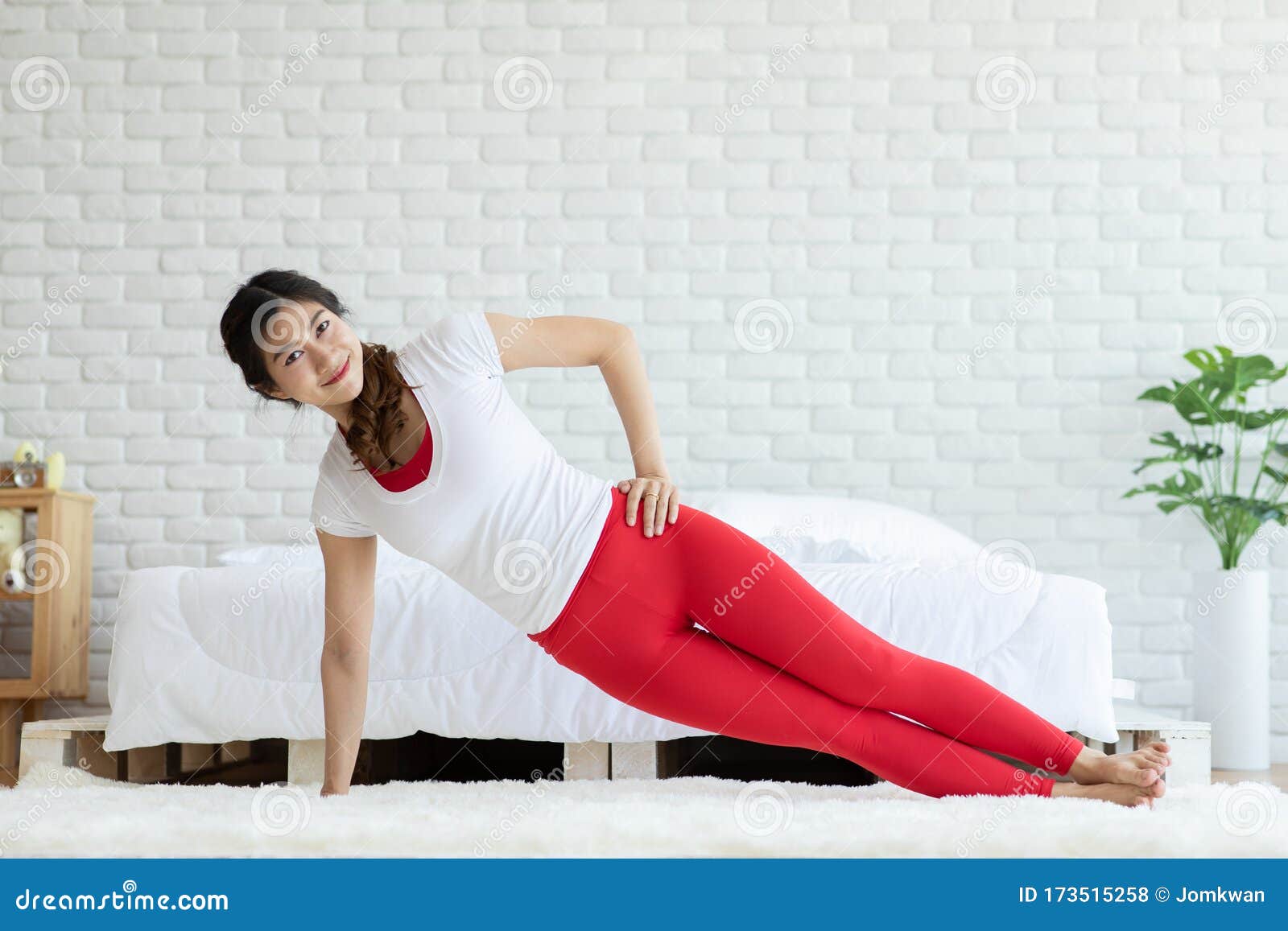 Attractive Asian Woman Practice Yoga Side Plank Pose To Meditation In