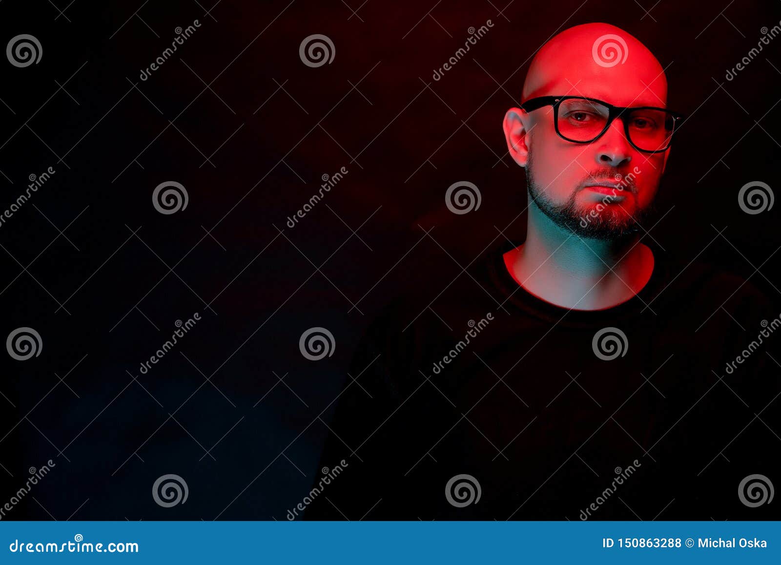 Attractive Bald Man with Beard in Glasses on Neon Light Background ...