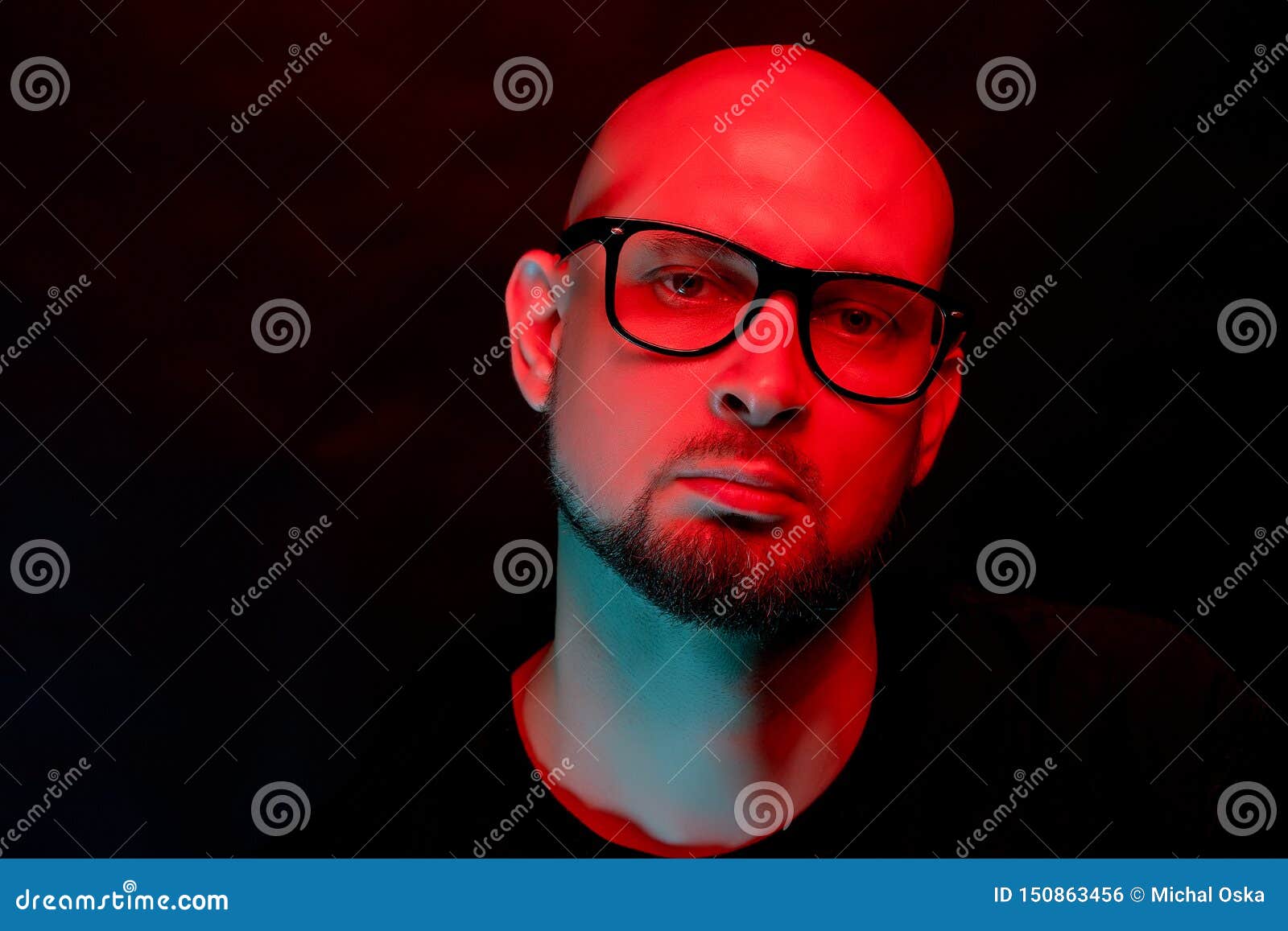Attractive Bald Man with Beard in Glasses on Neon Light Background ...