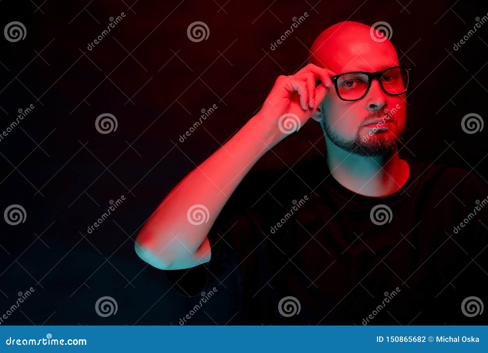 Attractive Bald Man with Beard in Glasses on Neon Light Background ...