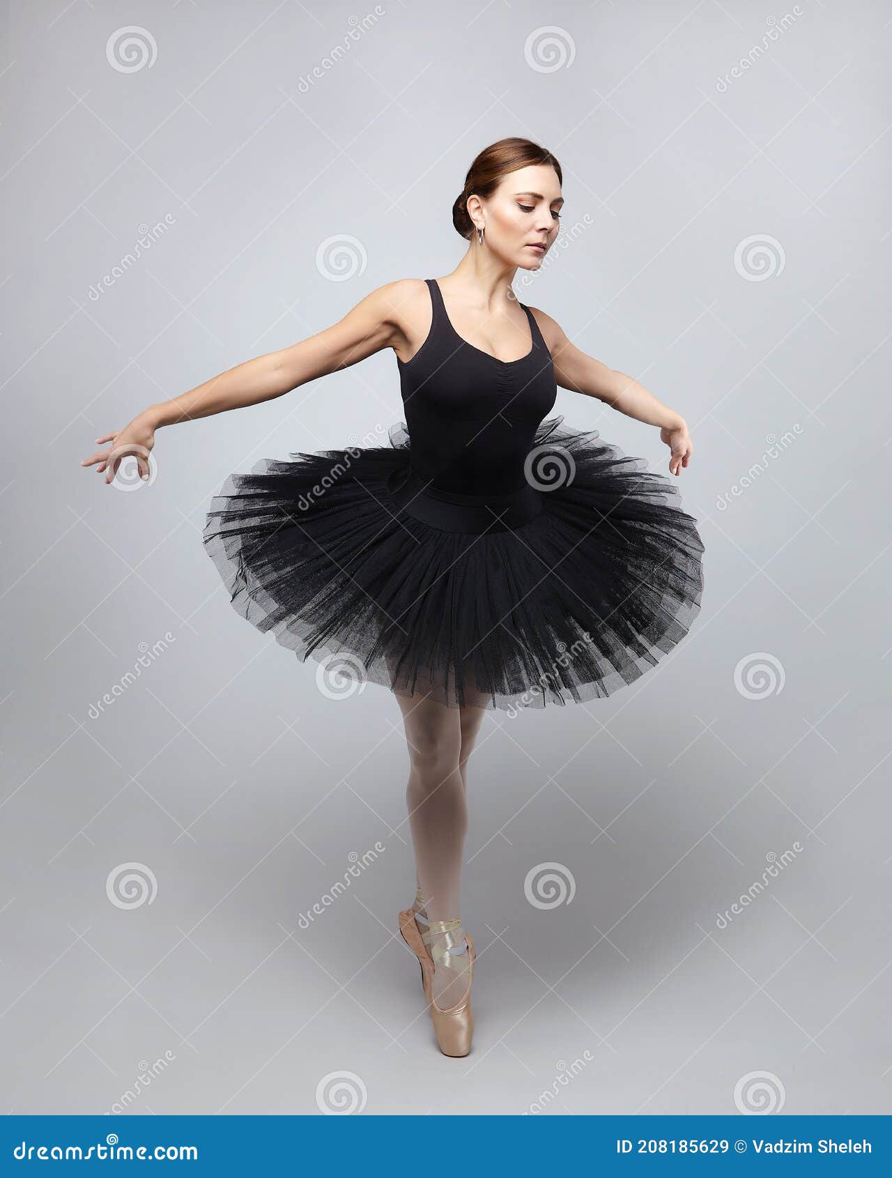 Attractive Ballerina Poses Gracefully In The Studio On A White ...