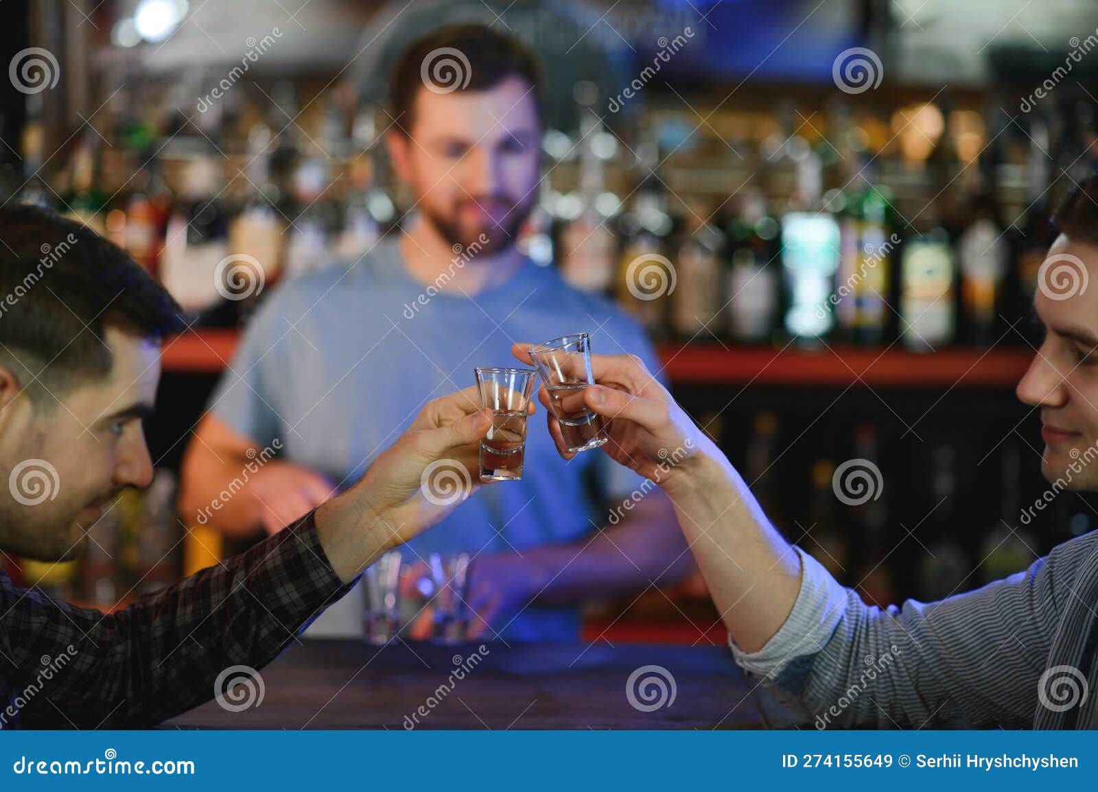 Attractive Bartender is Smiling and Taking Order of Two Men Sitting at ...