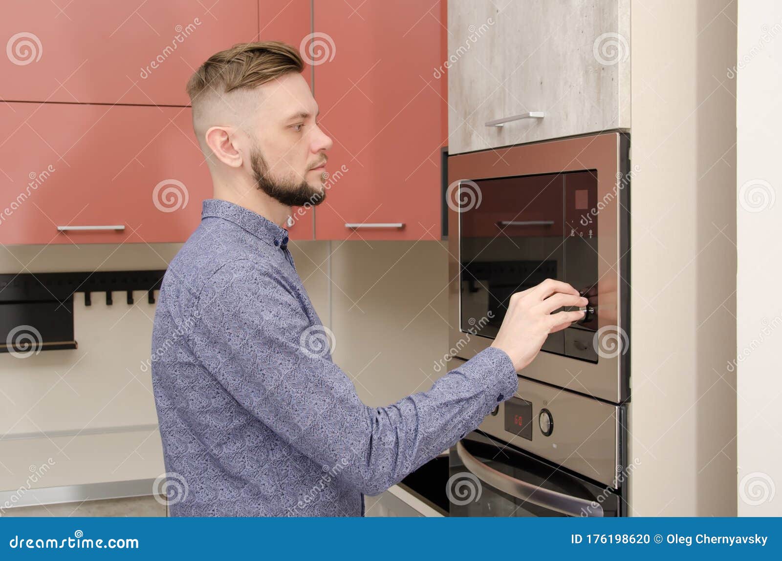 Attractive Bearded Man Sets Microwave Oven Timer in Modern Kitchen ...