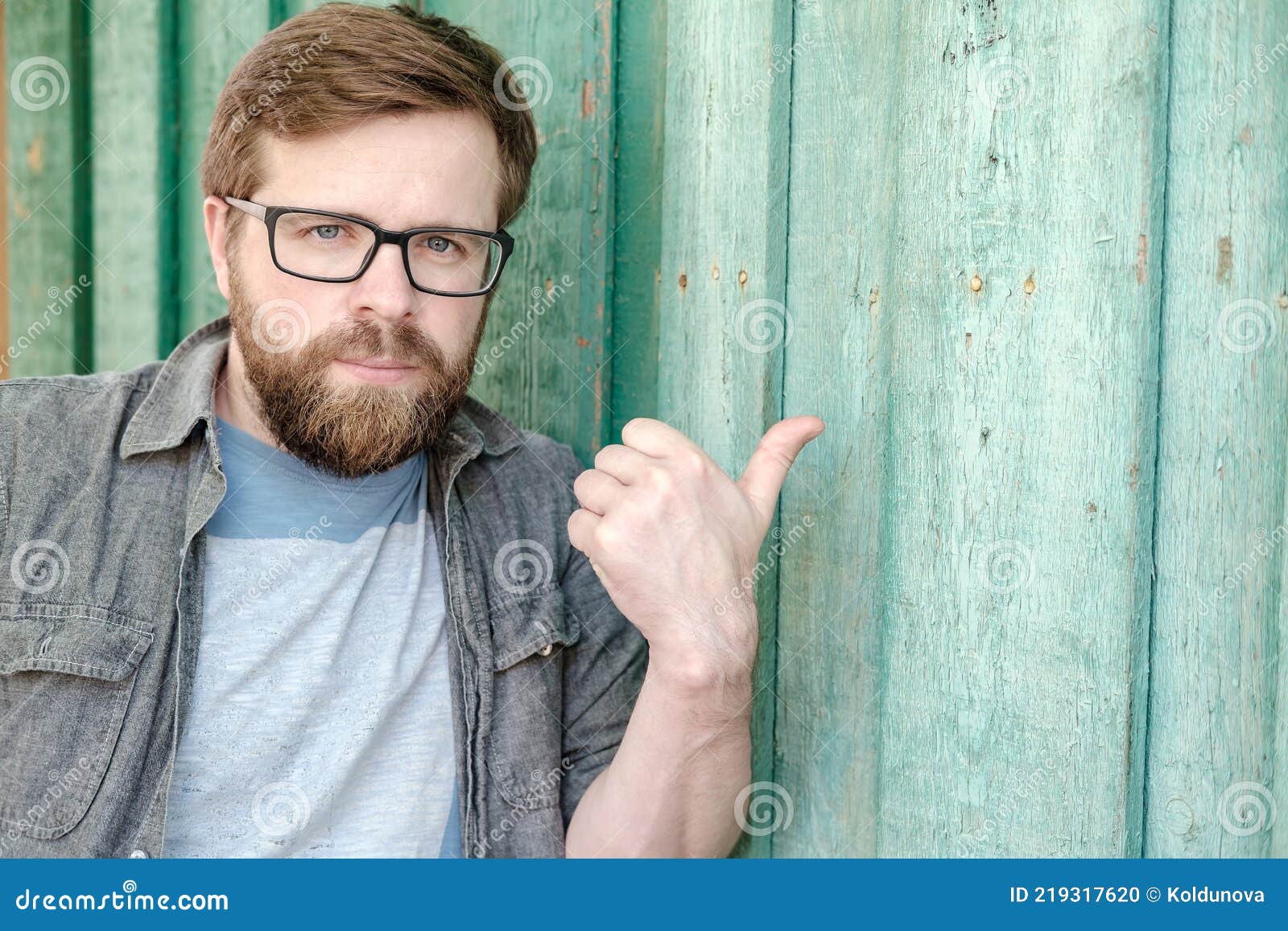 Attractive Bearded Man Wearing Glasses Makes An Approving Gesture