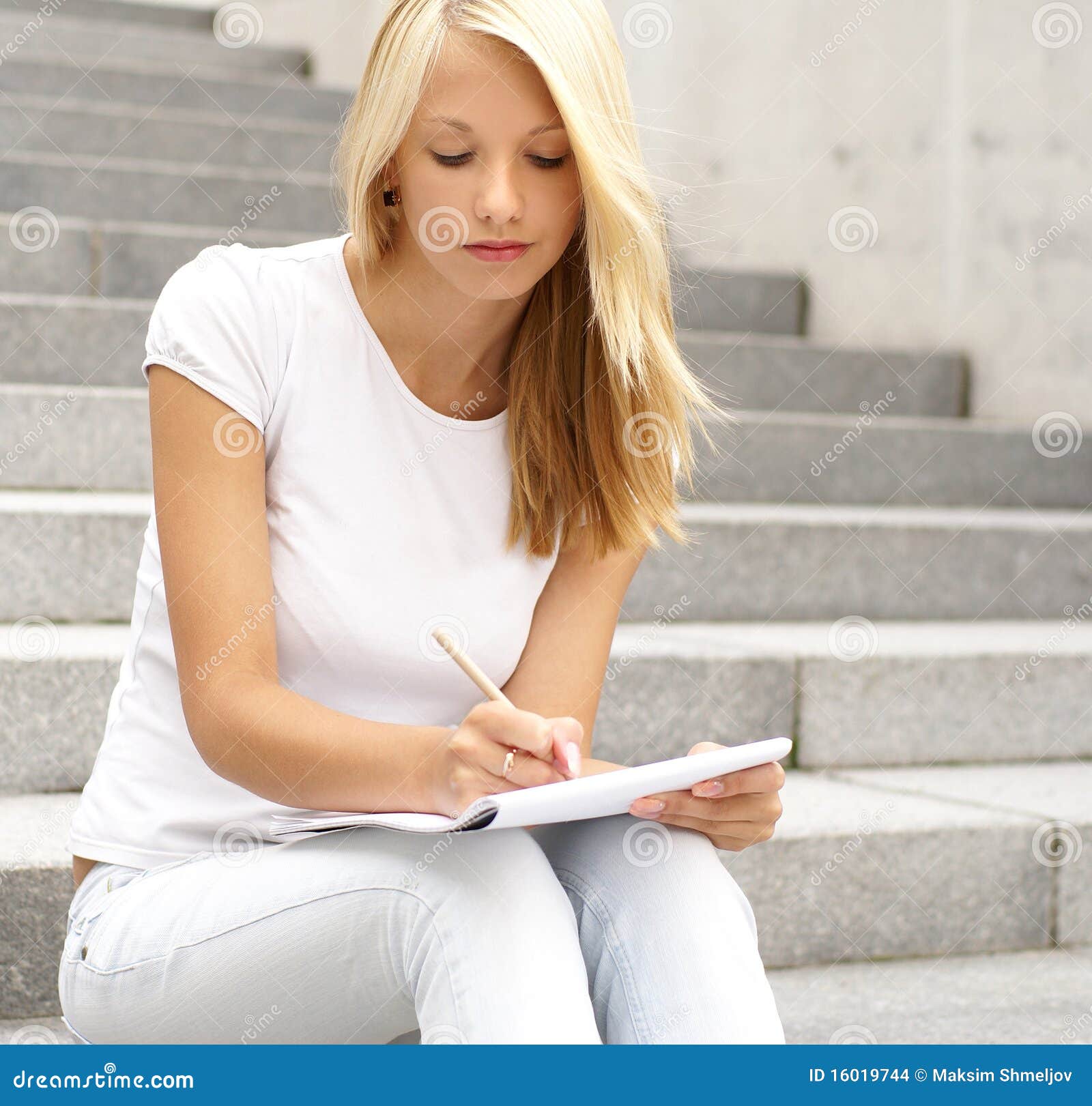 An Attractive Blond Girl is Writing a Note Stock Photo - Image of girl ...
