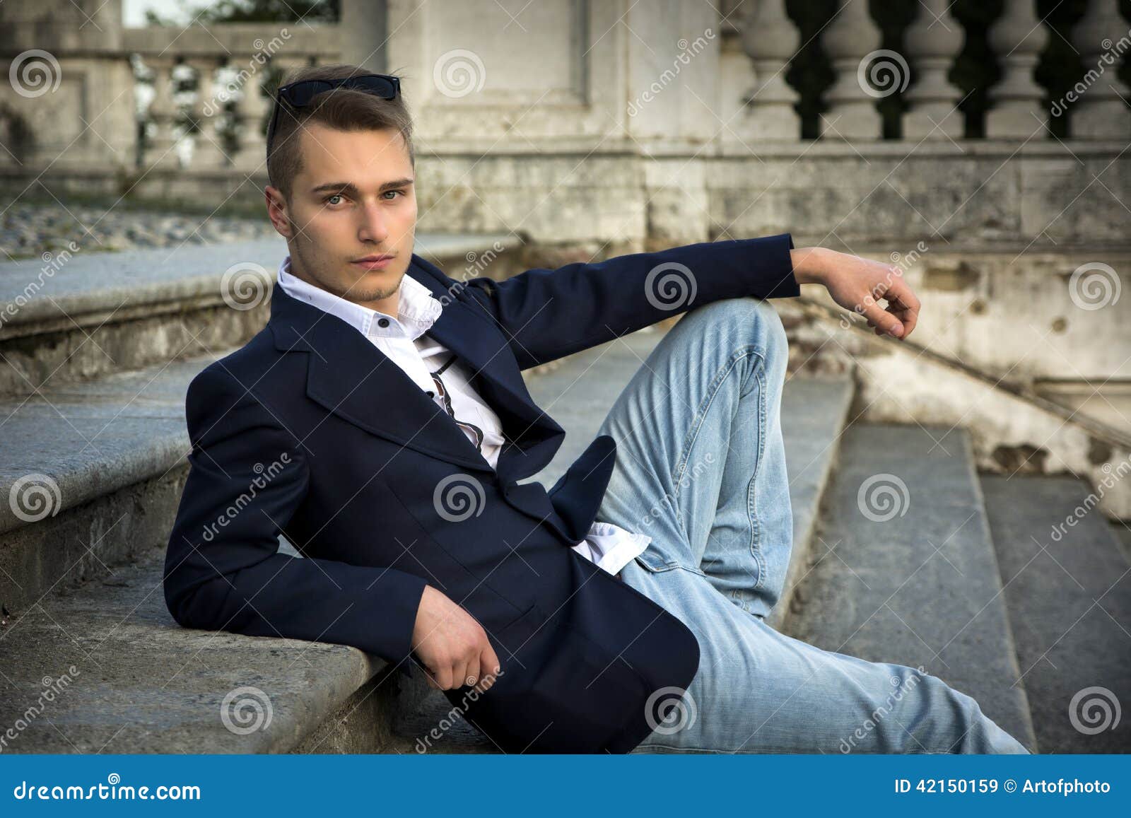 Attractive Blond Young Man Sitting on Stone Stair Steps Outside Stock ...