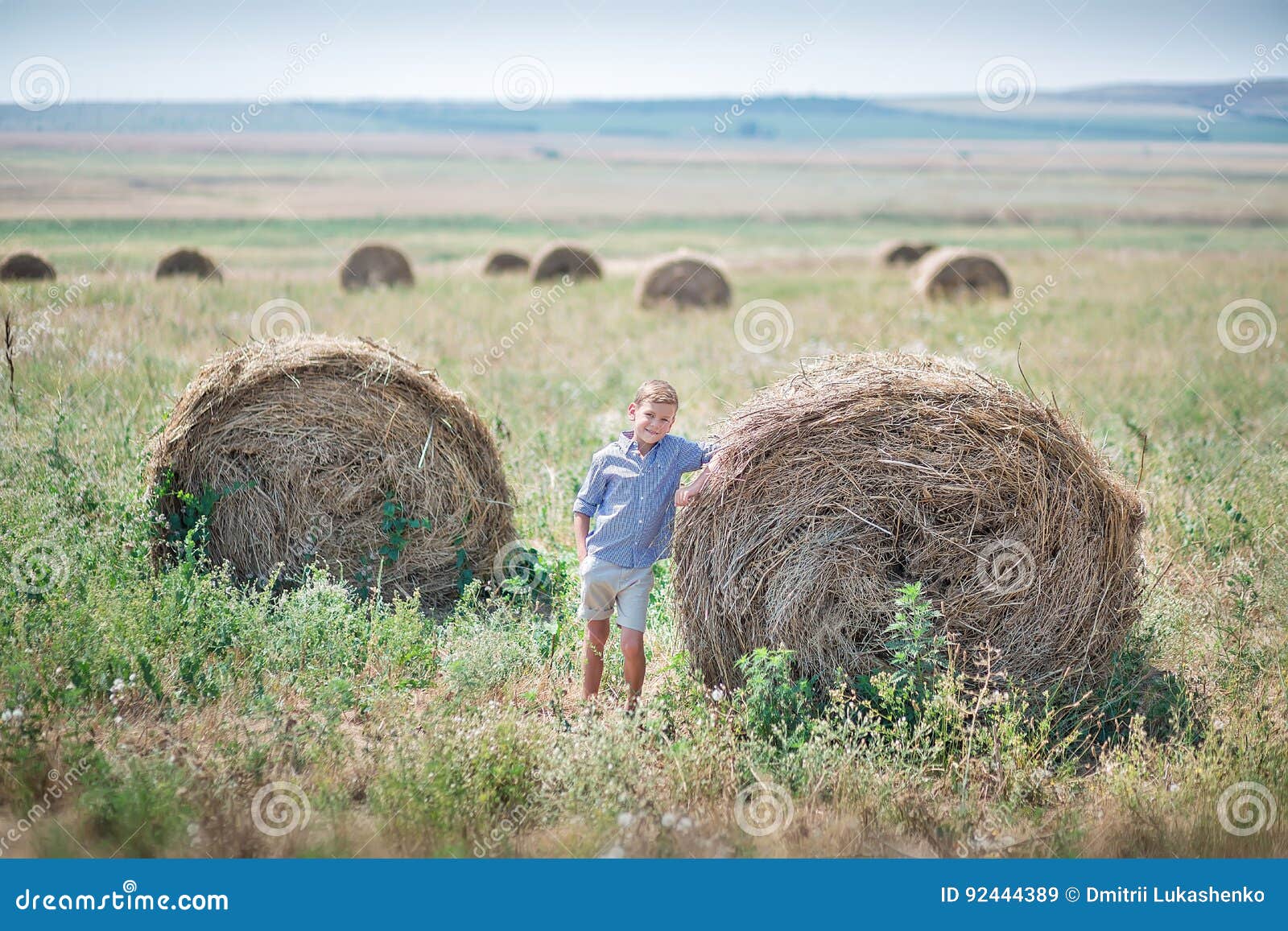Attractive Boy Sitting on a Haystack and Smiling Stock Image - Image of ...
