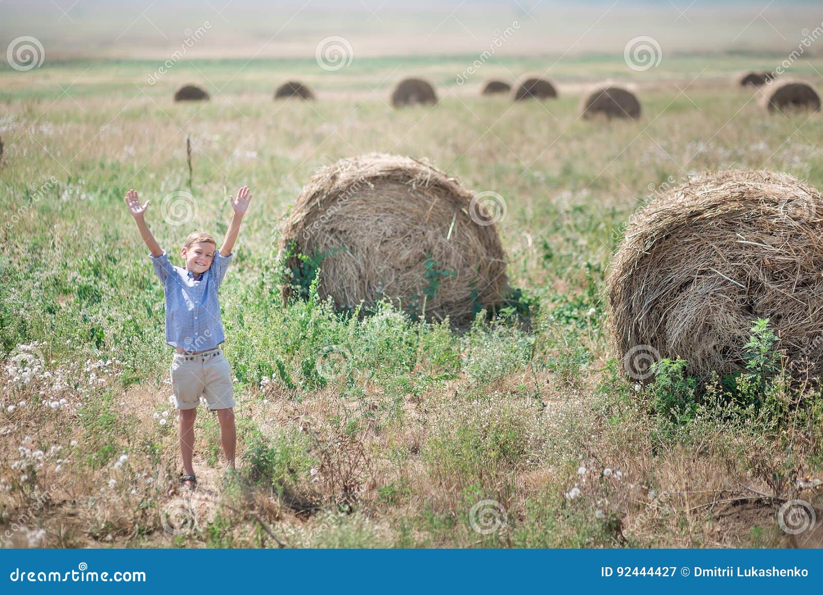 Attractive Boy Sitting on a Haystack and Smiling Stock Image - Image of ...