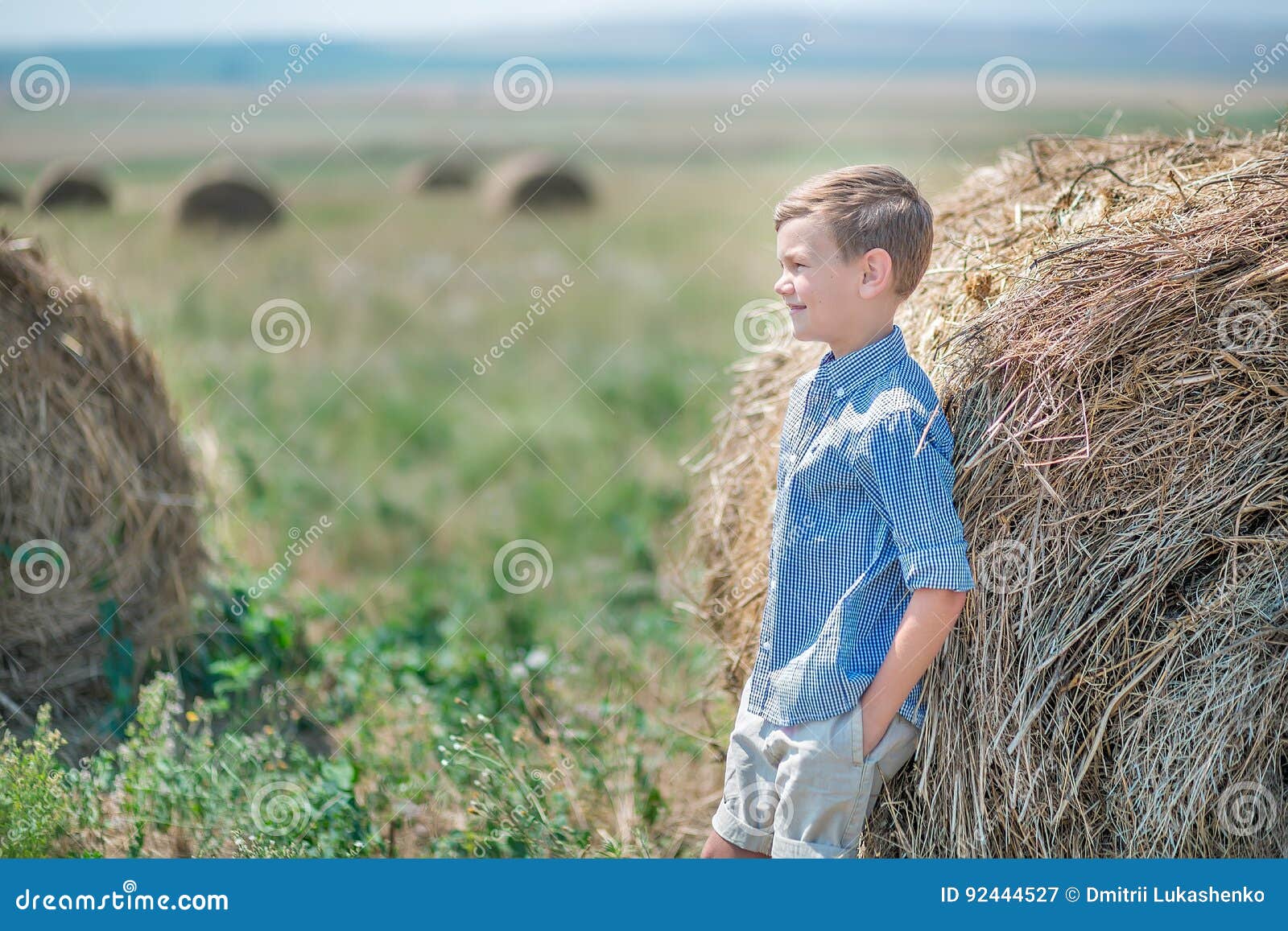 Attractive Boy Sitting on a Haystack and Smiling Stock Image - Image of ...