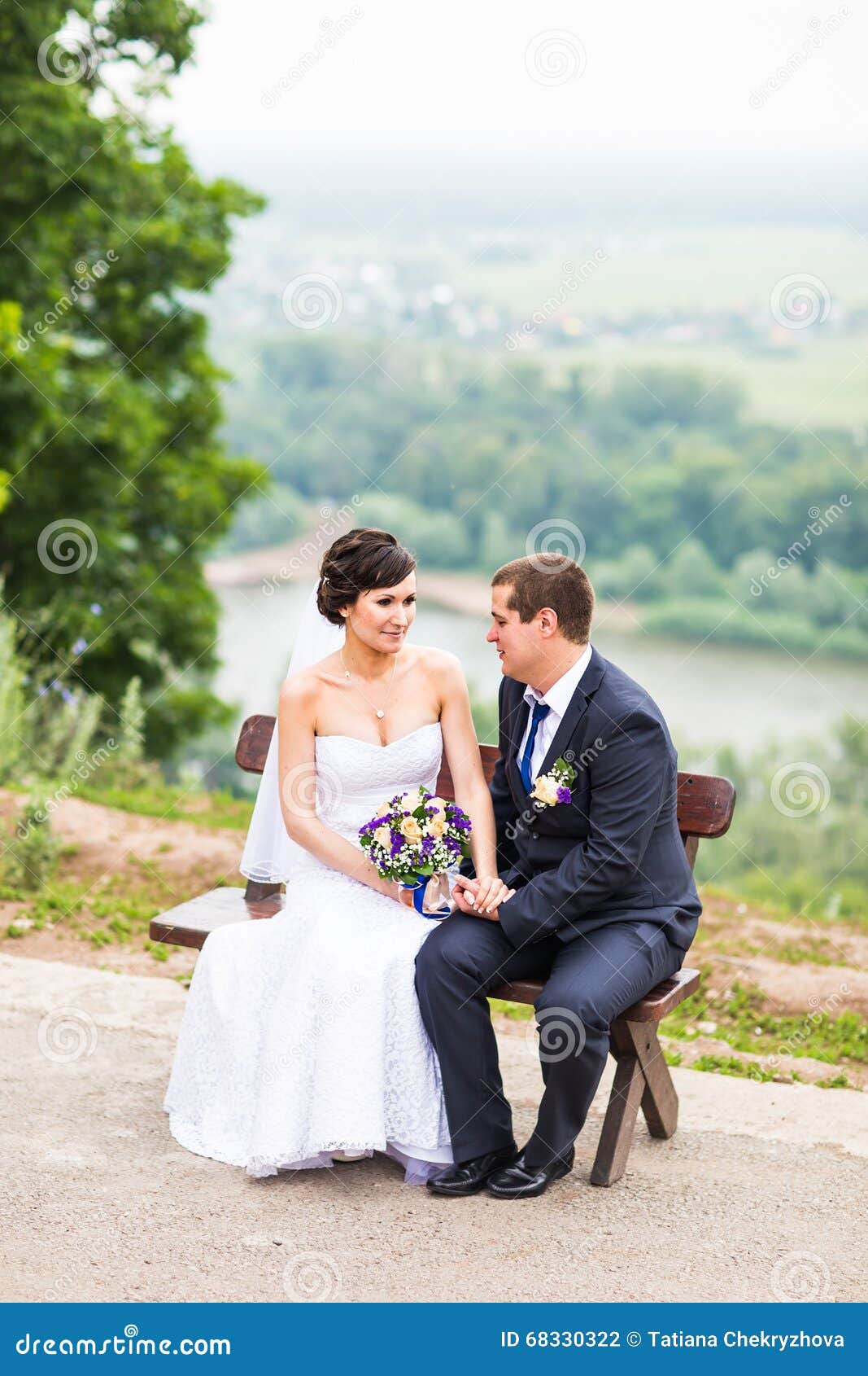 Attractive Bride and Groom Sitting on a Bench Stock Photo - Image of ...