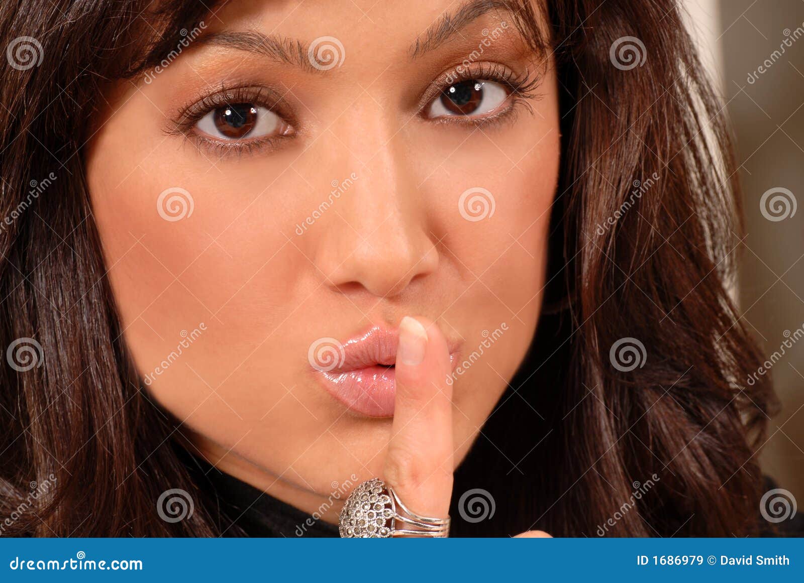 Attractive Brunette with Her Finger To Her Lips Stock Image - Image of ...