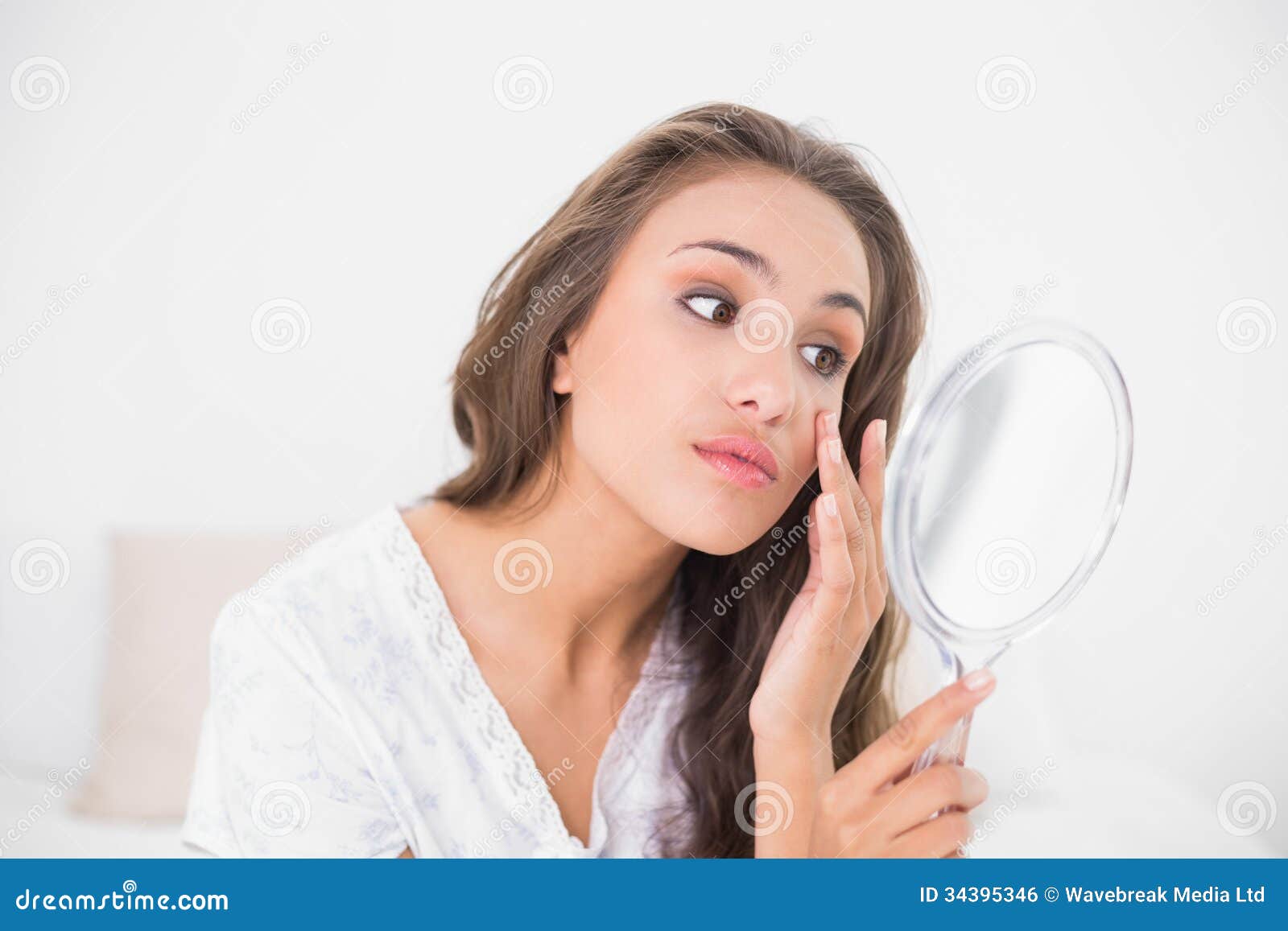 Attractive Brunette Looking Closely at Mirror Stock Photo - Image of ...