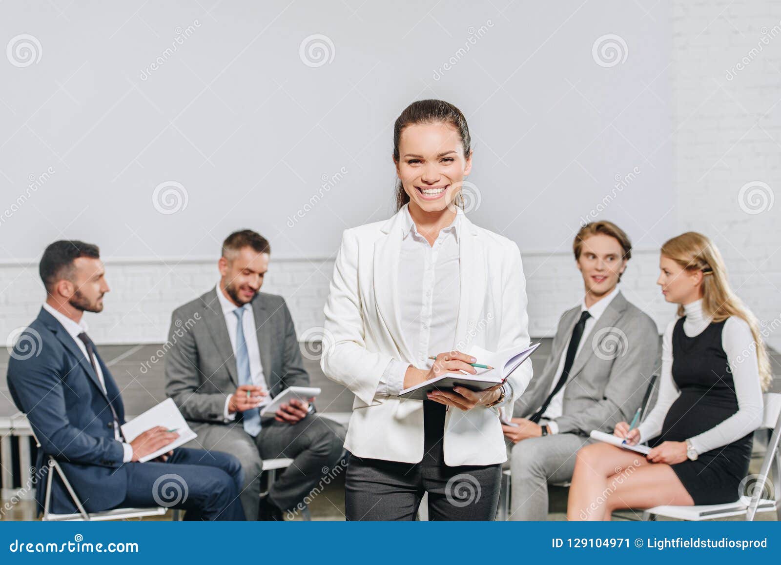 Attractive Business Coach Standing in Front of Businesspeople at ...