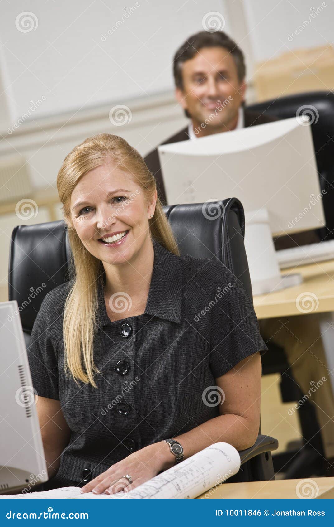 Attractive Business People Sitting at Desks. Stock Photo - Image of ...