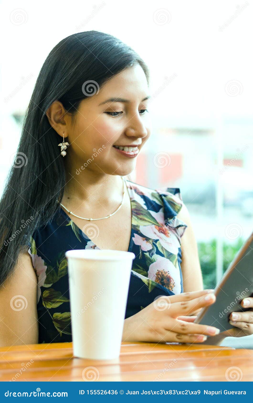 Attractive Business Woman Drinking a Coffee and Using a Digital Tablet ...