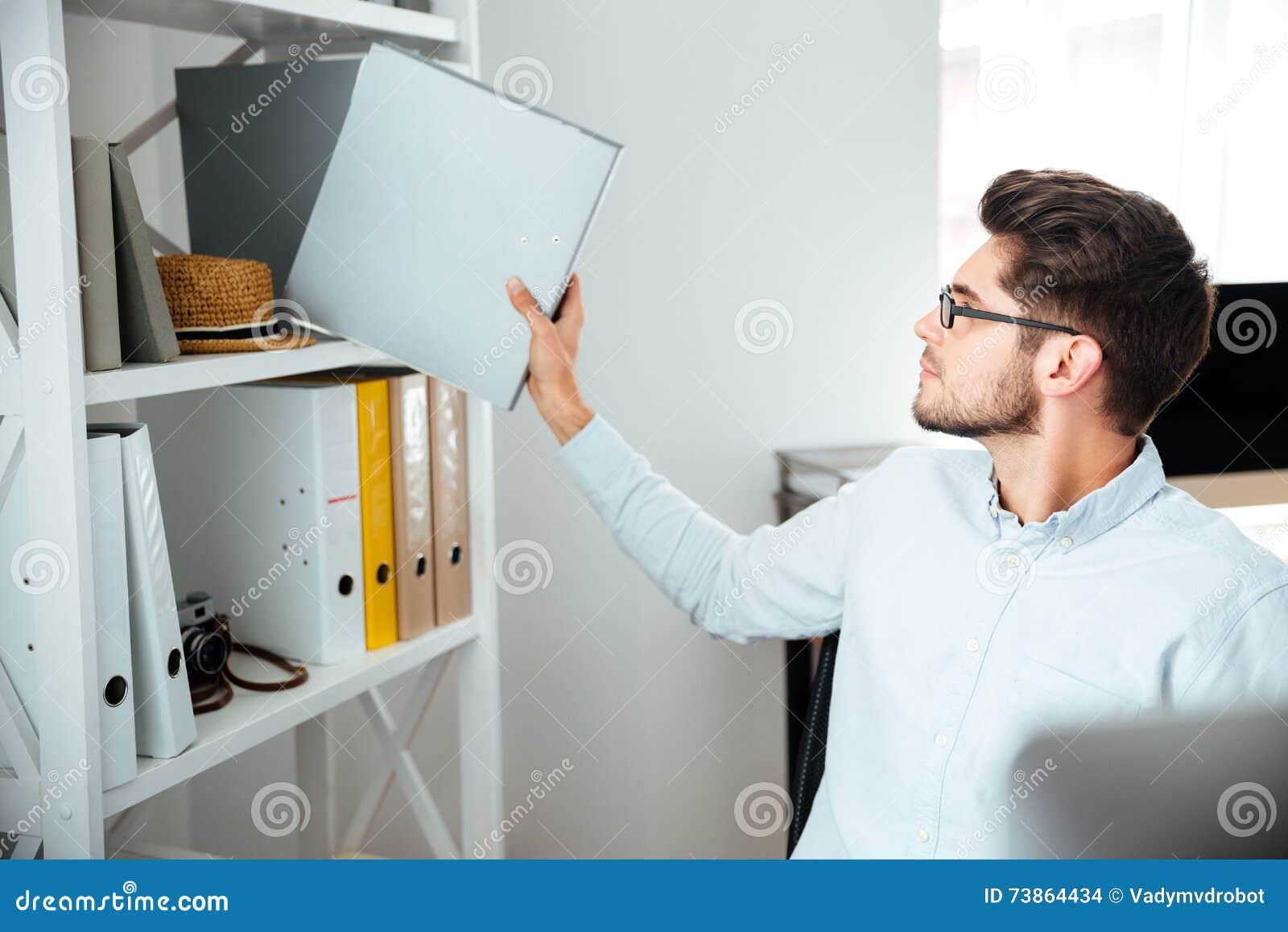 Attractive Businessman Sitting and Taking Folder with Documents in ...