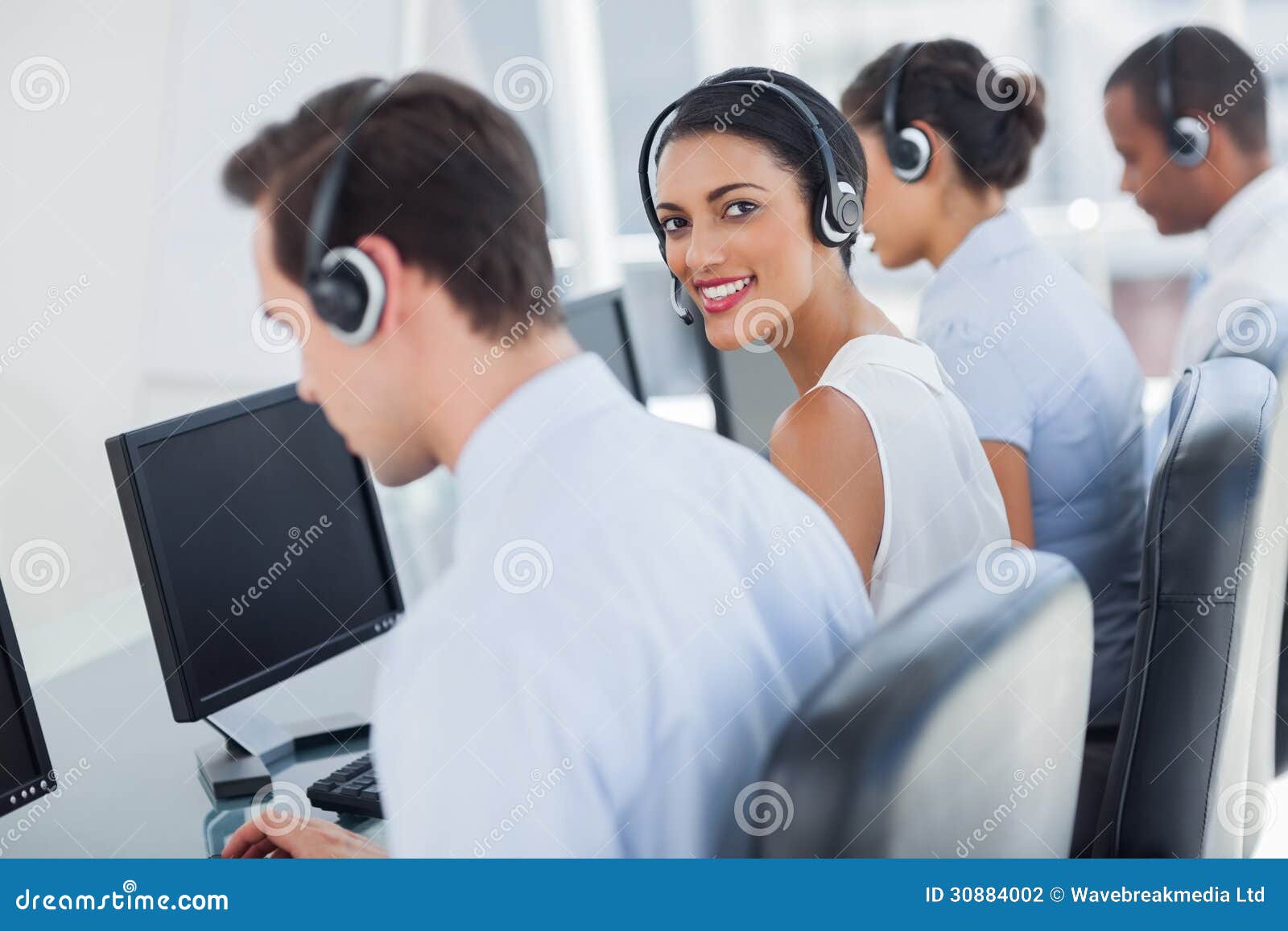 Attractive Call Centre Employee Looking Over Shoulder Stock Photo ...