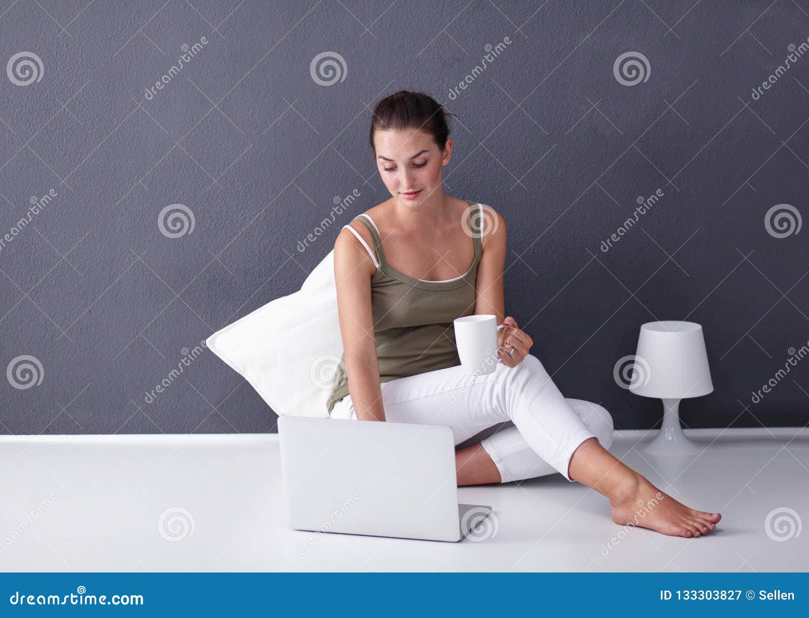 Attractive Caucasian Girl Sitting On Floor With Cup And Tablet Near