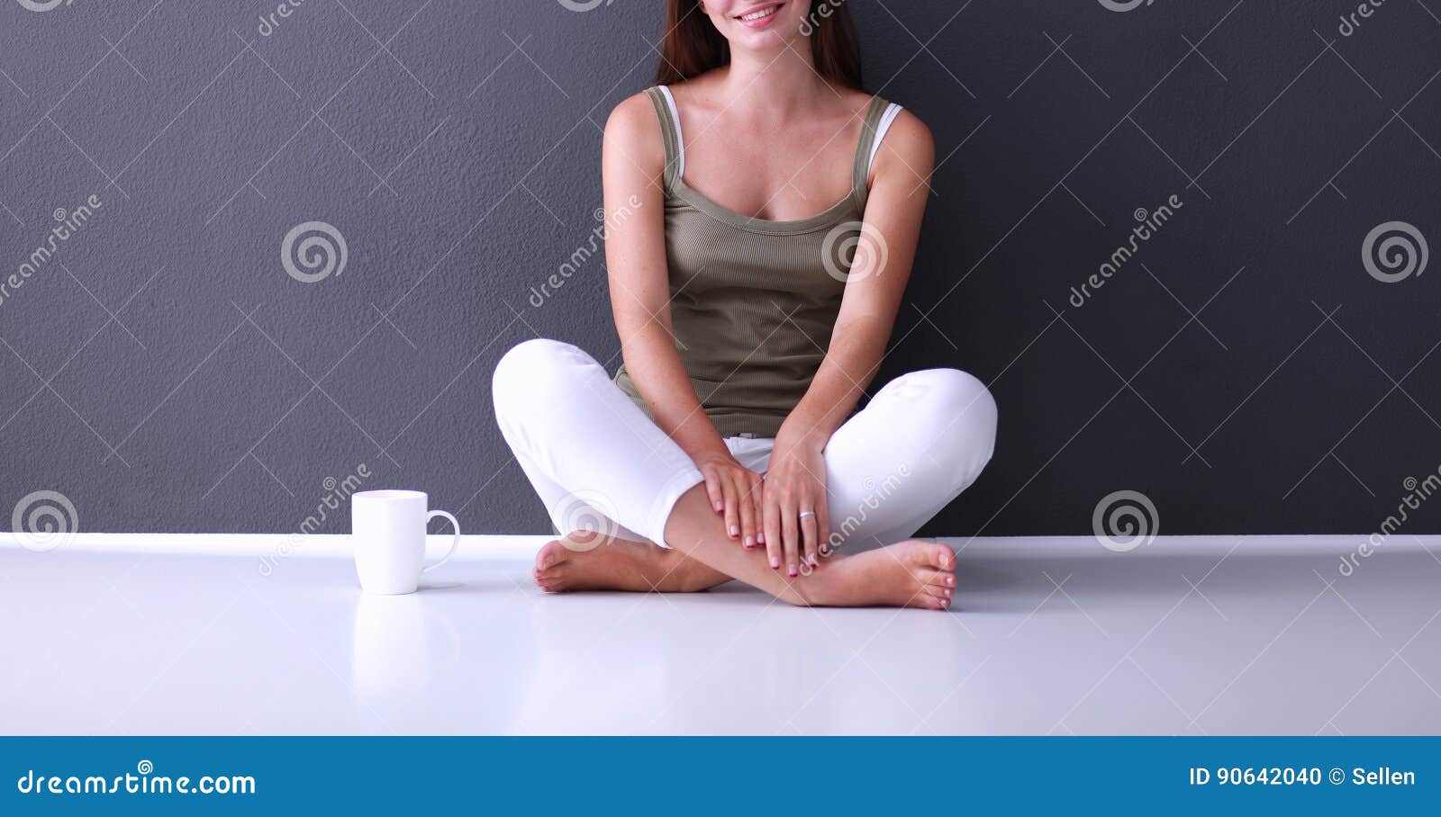 Attractive Caucasian Girl Sitting On Floor With Cup And Tablet Near