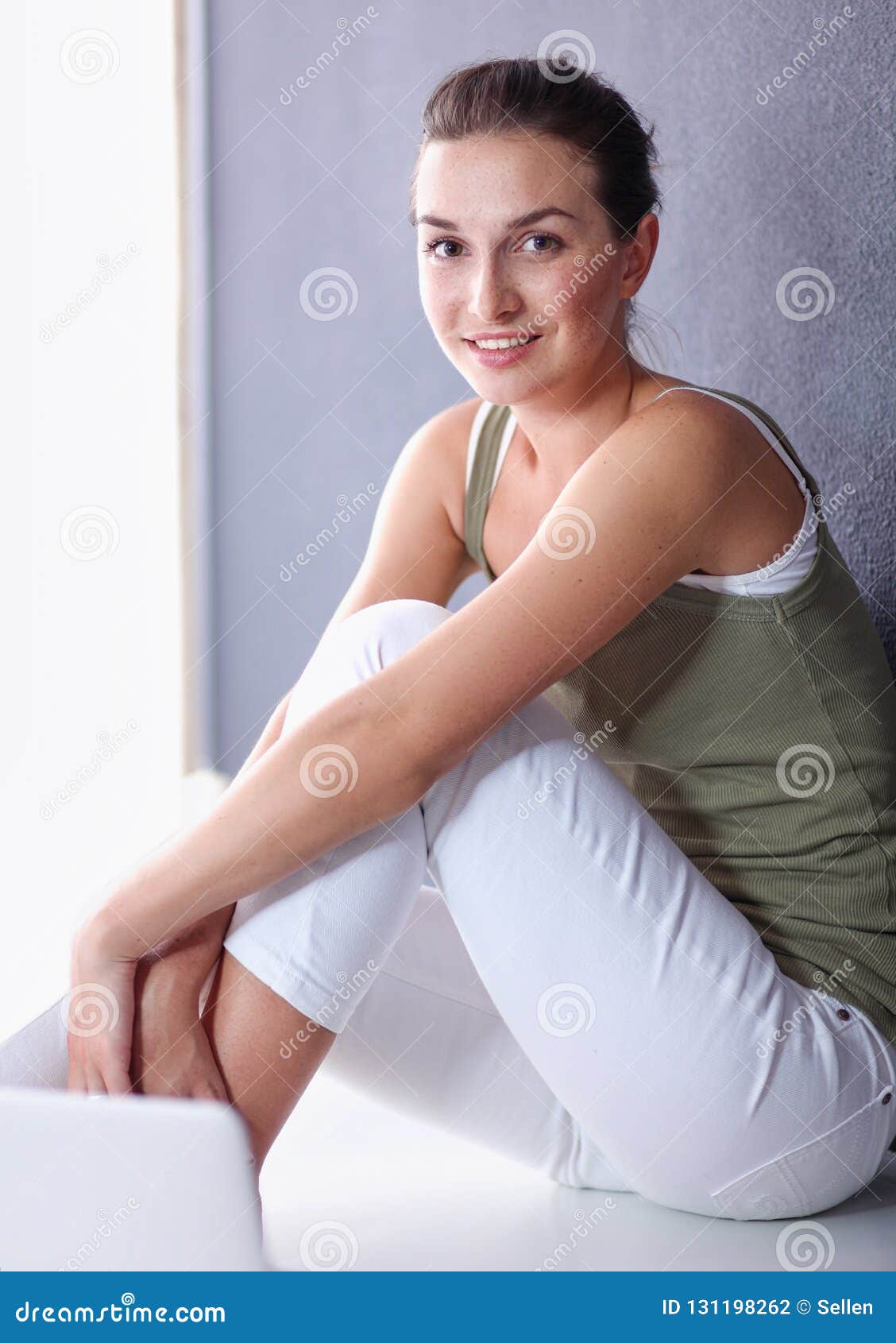 Attractive Caucasian Girl Sitting On Floor With Cup And Tablet Near