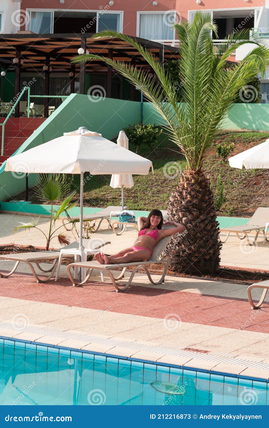 Attractive Caucasian Woman Resting Under Palm Tree in the Poolside ...