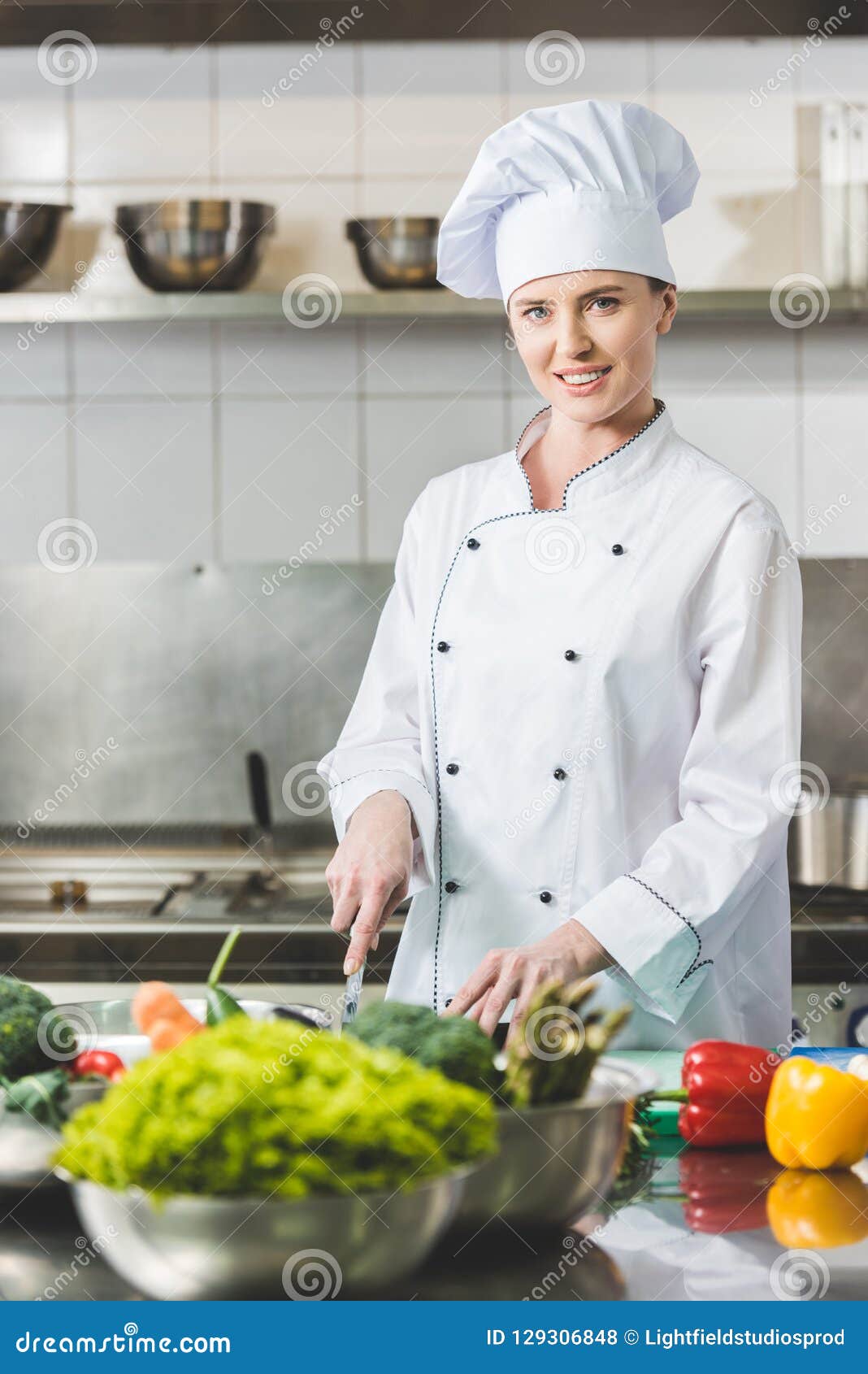 Attractive Chef Cutting Vegetables at Restaurant Kitchen and Looking ...