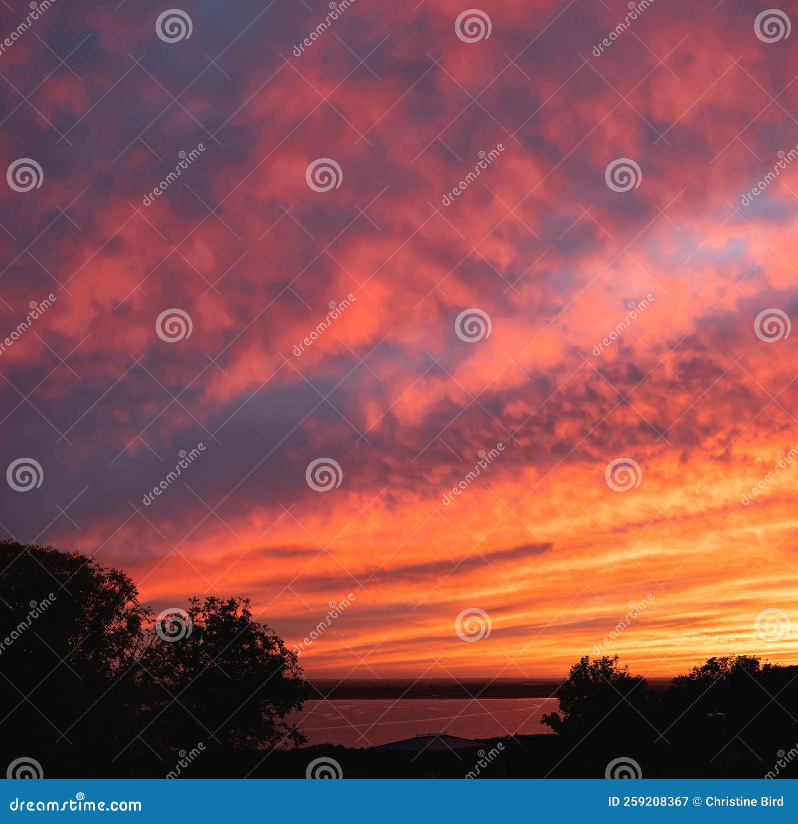 Attractive Colours and Textures of Clouds at Sunset Over a Bay of Water ...