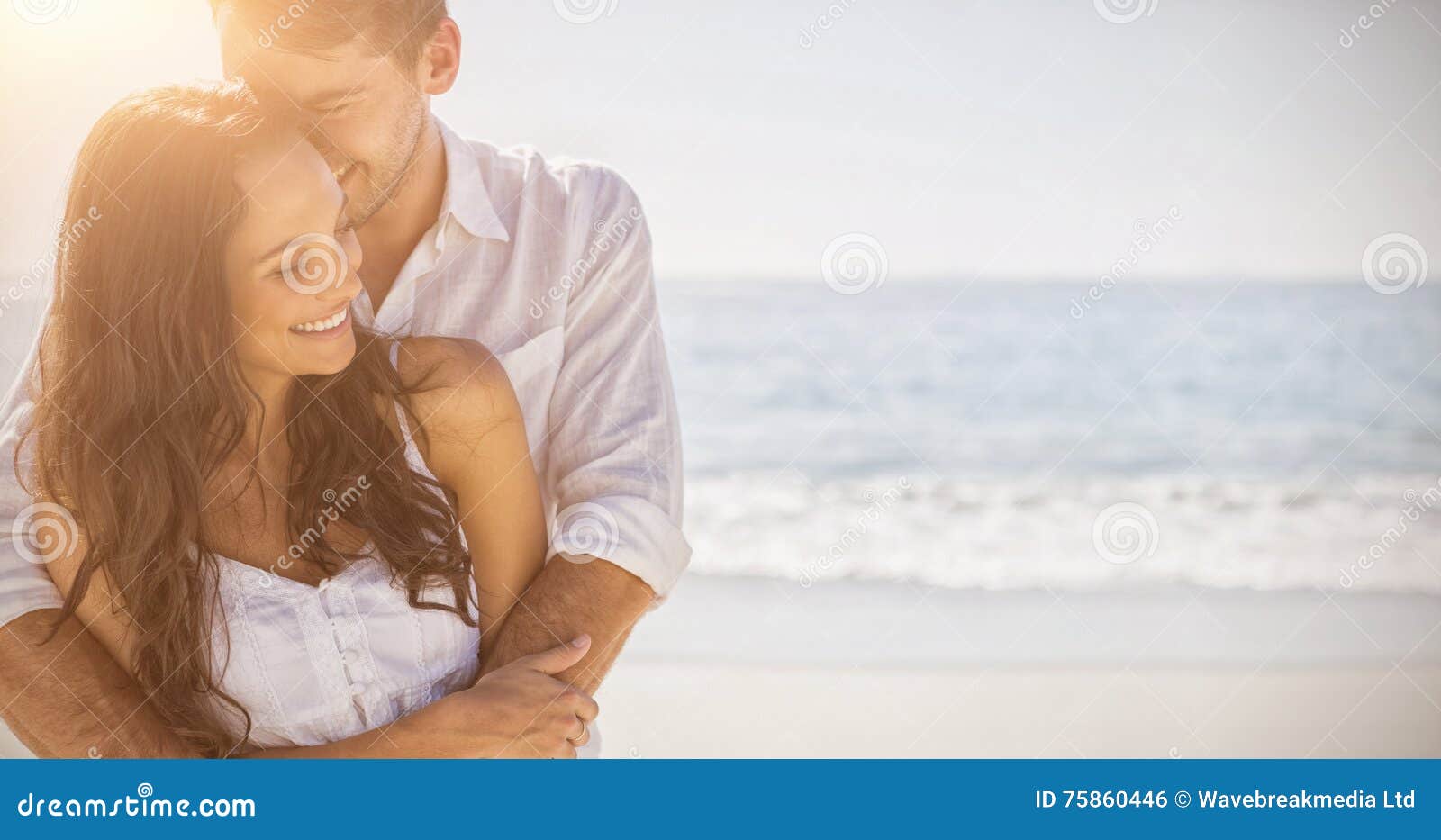 Attractive couple cuddling stock photo. Image of handsome - 75860446