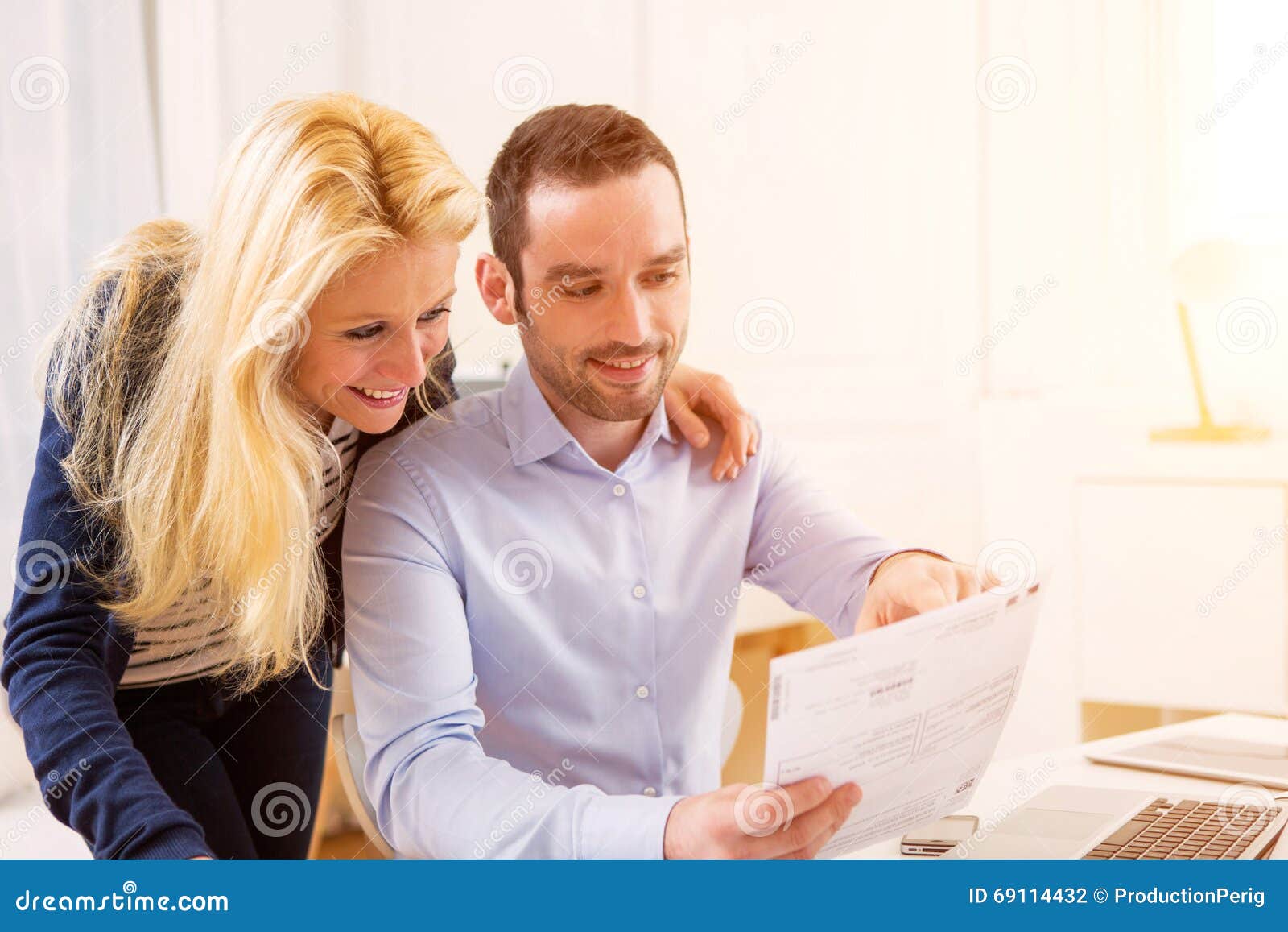 Attractive Couple Doing Administrative Paperwork Stock Photo - Image of ...