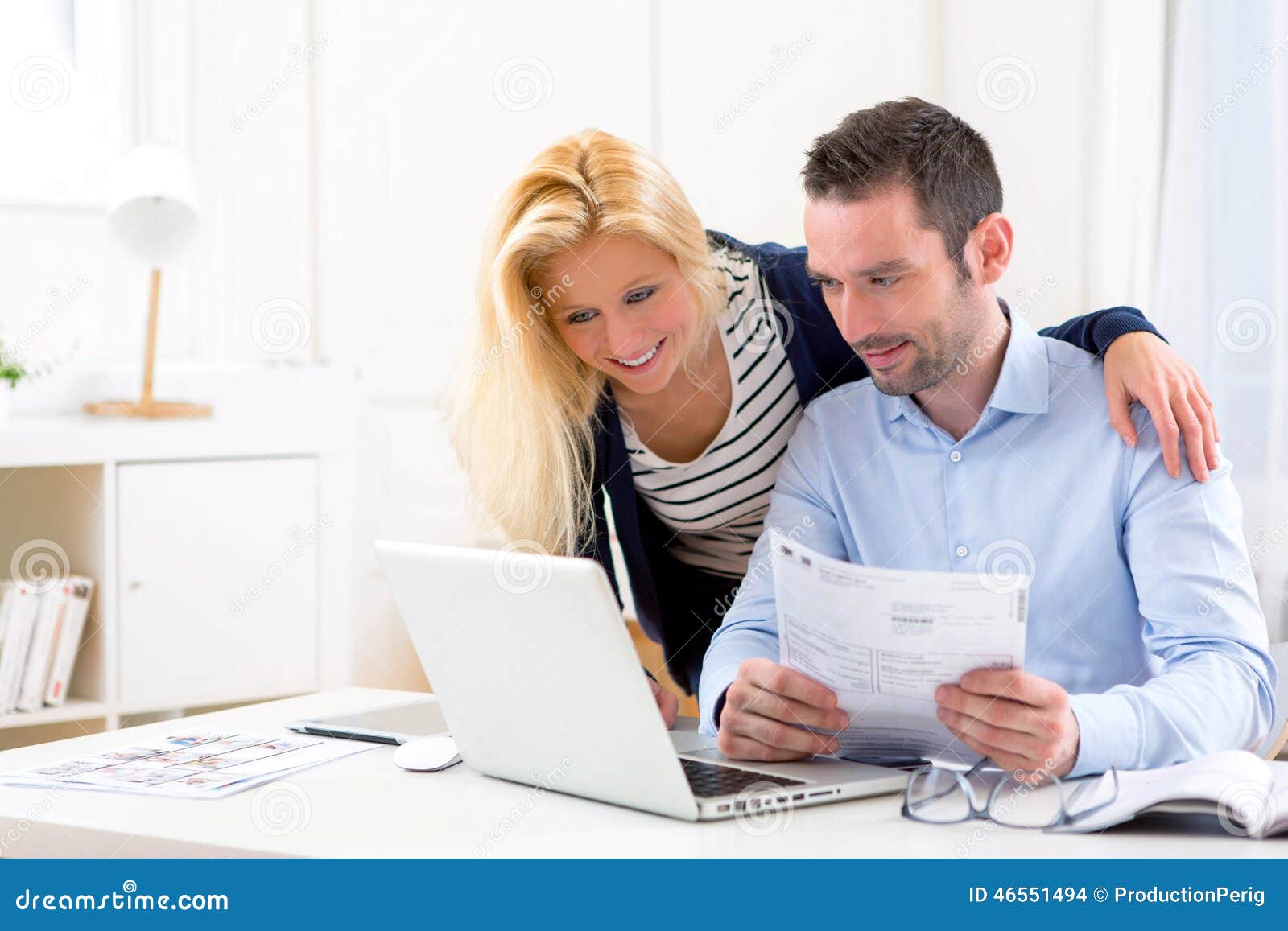 Attractive Couple Doing Administrative Paperwork Stock Photo - Image of ...