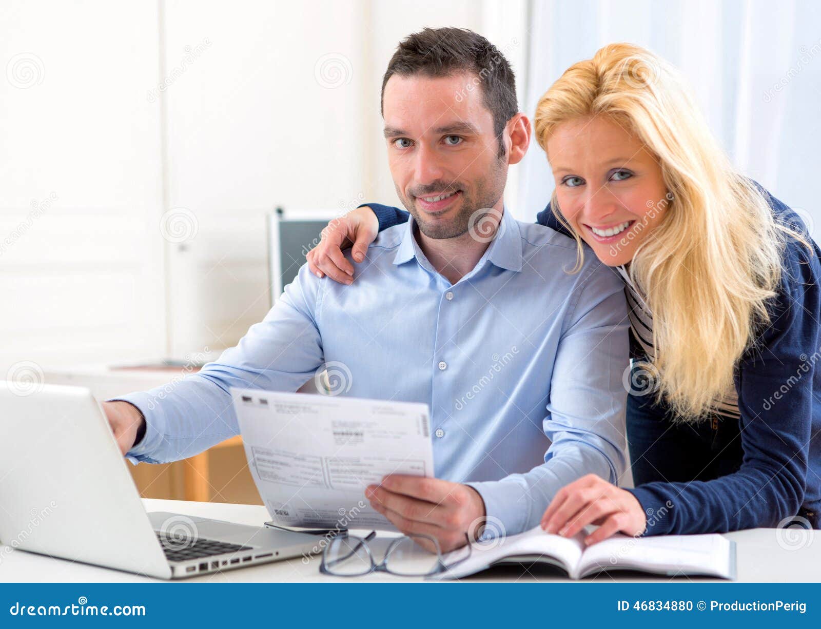Attractive Couple Doing Administrative Paperwork Stock Photo - Image of ...