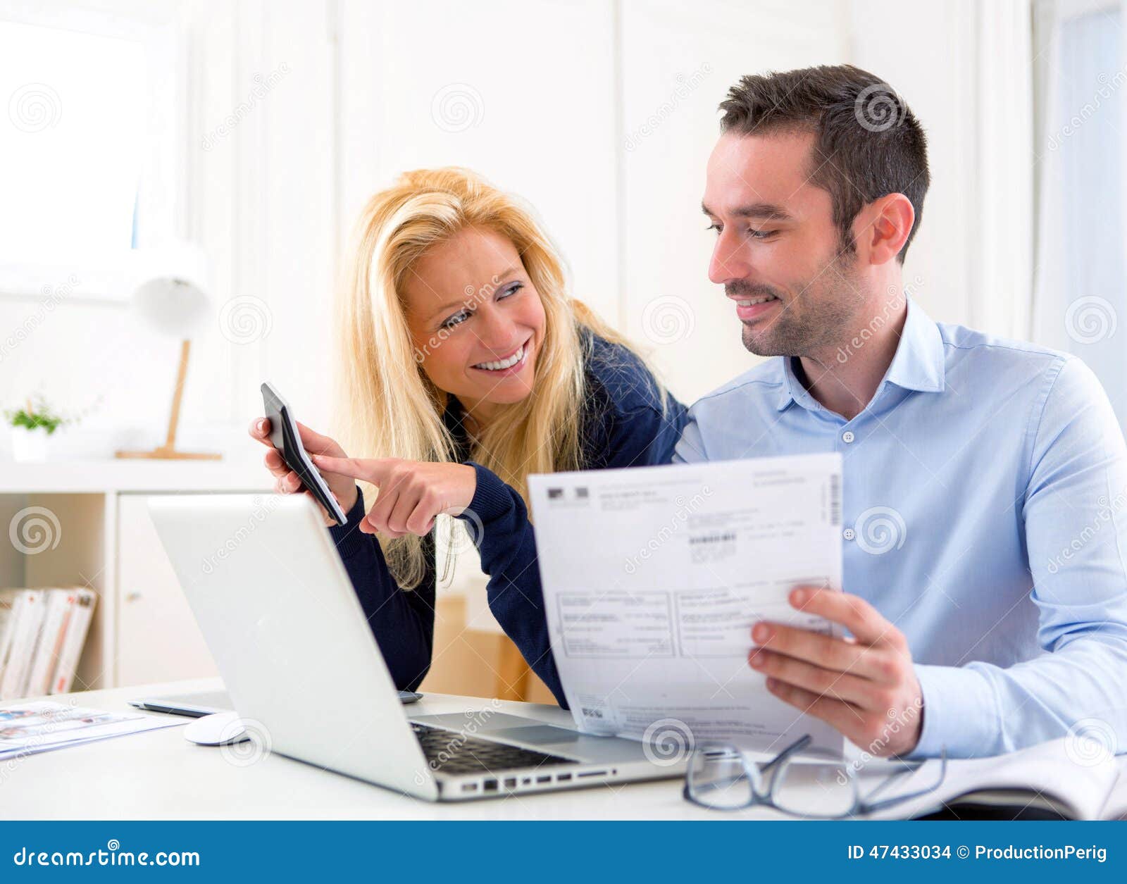 Attractive Couple Doing Administrative Paperwork Stock Photo - Image of ...