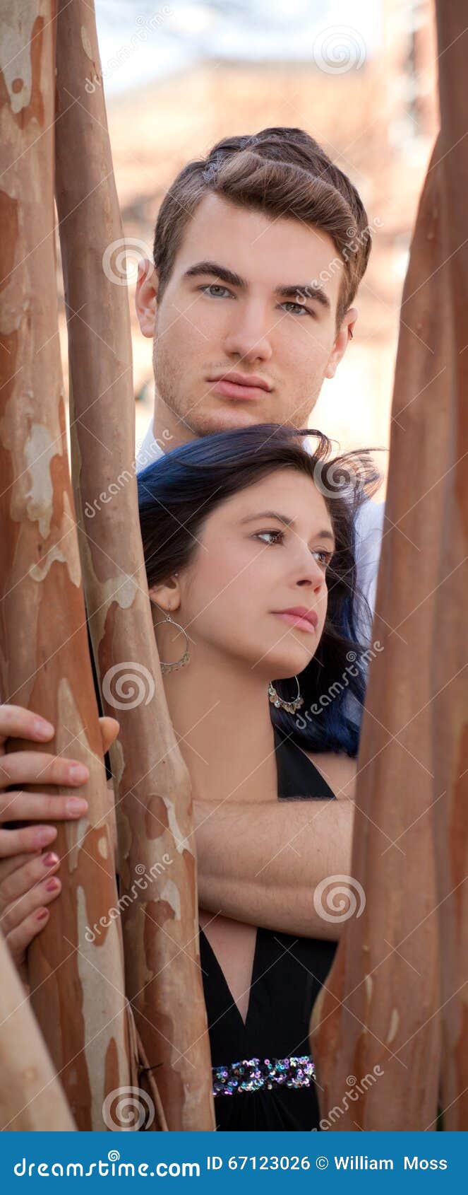 Attractive Couple through Trees Stock Photo - Image of outdoors ...