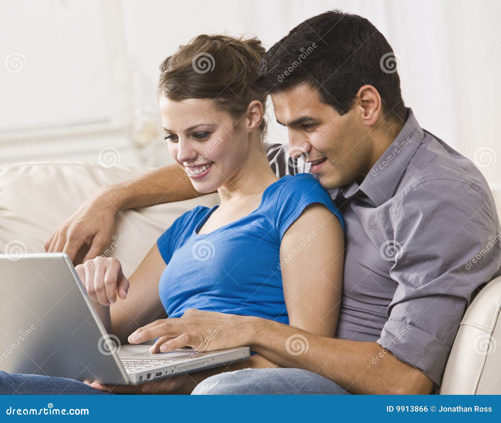 Attractive Couple Working on Laptop Together Stock Photo - Image of ...