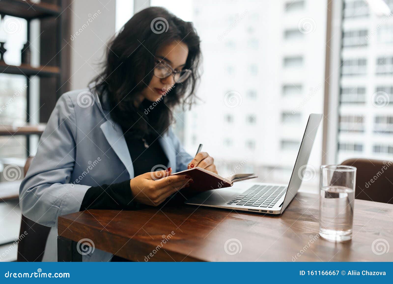 Attractive Cute Office Worker Writing Something on Her Notepad Stock ...
