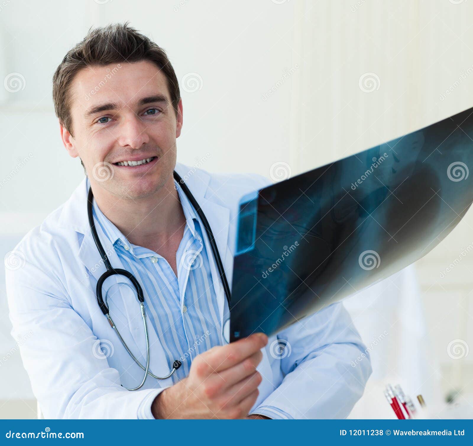 Attractive Doctor Examining an X-ray Stock Photo - Image of radiology ...