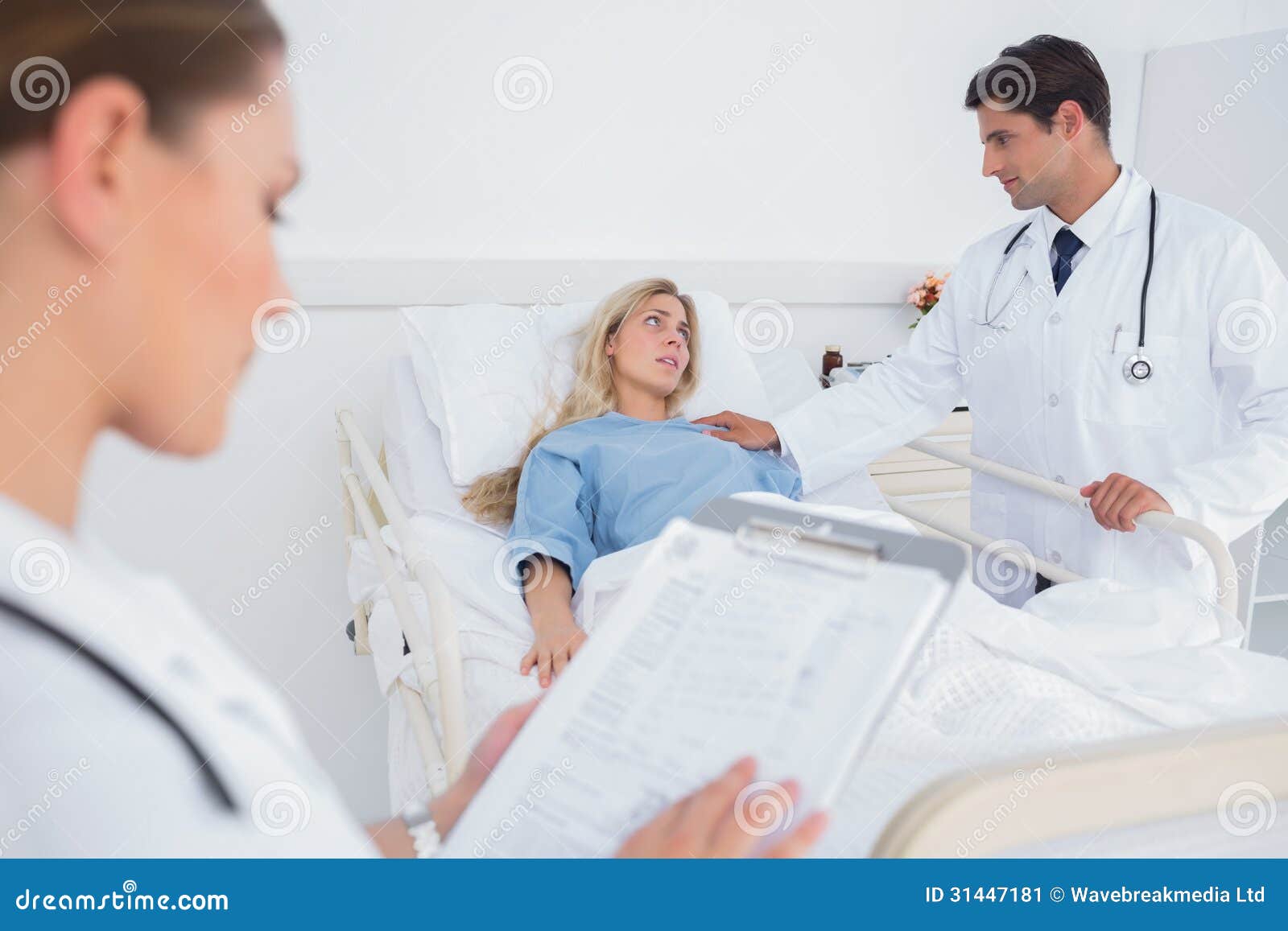 Attractive Doctor Taking Care of a Patient Stock Image - Image of light ...