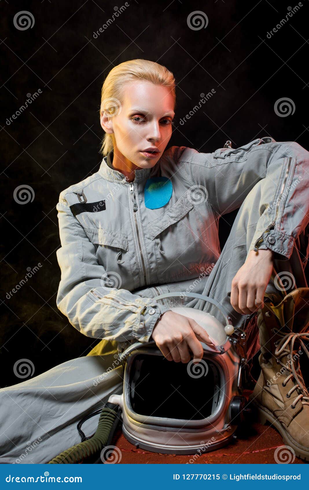 Attractive Female Astronaut in Spacesuit Holding Helmet and Sitting ... Attractive Female Astronaut in Spacesuit Holding Helmet and Sitting ...